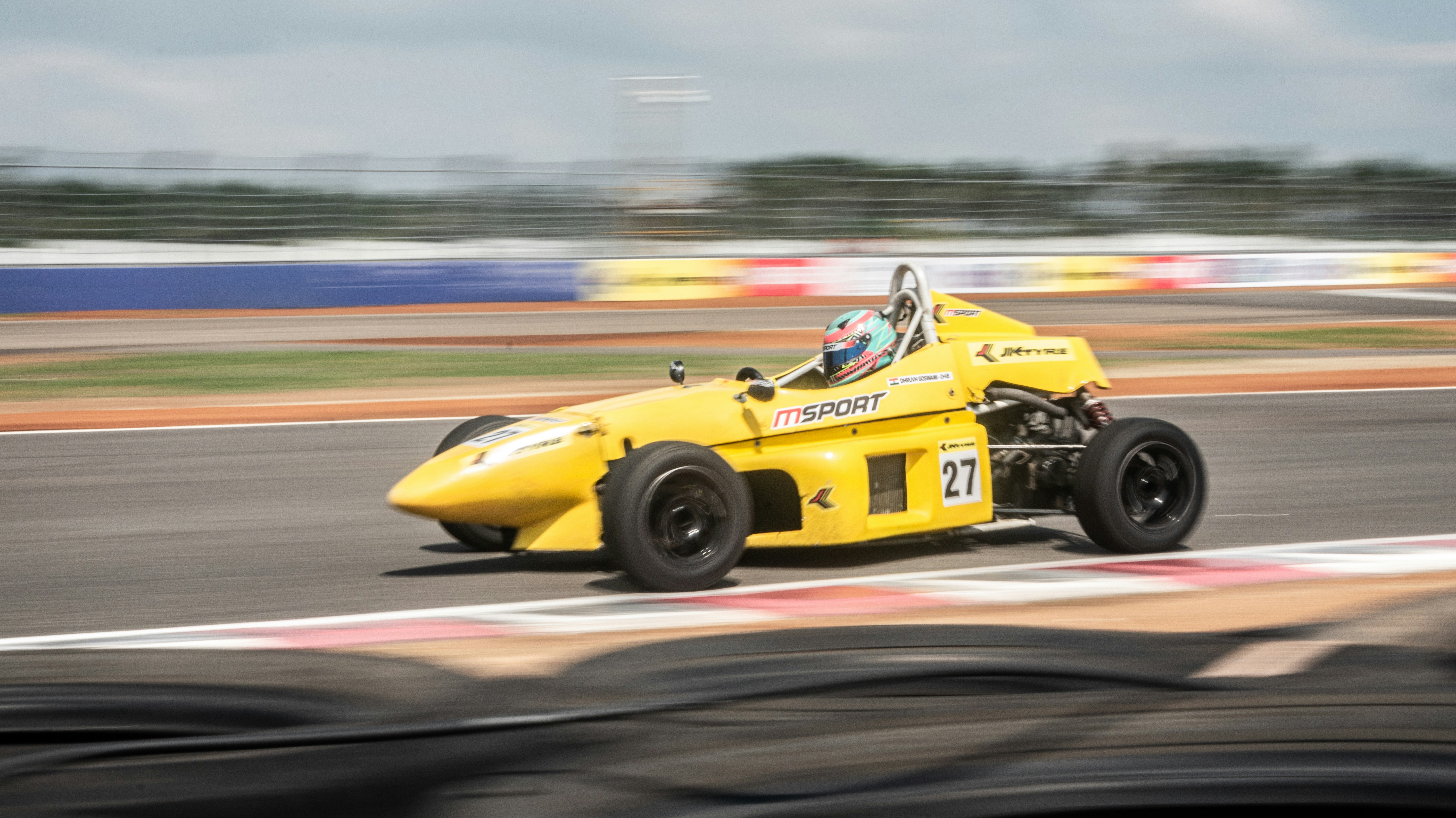 Yellow Lightning: a single-seat racer hurtles through a blurred track