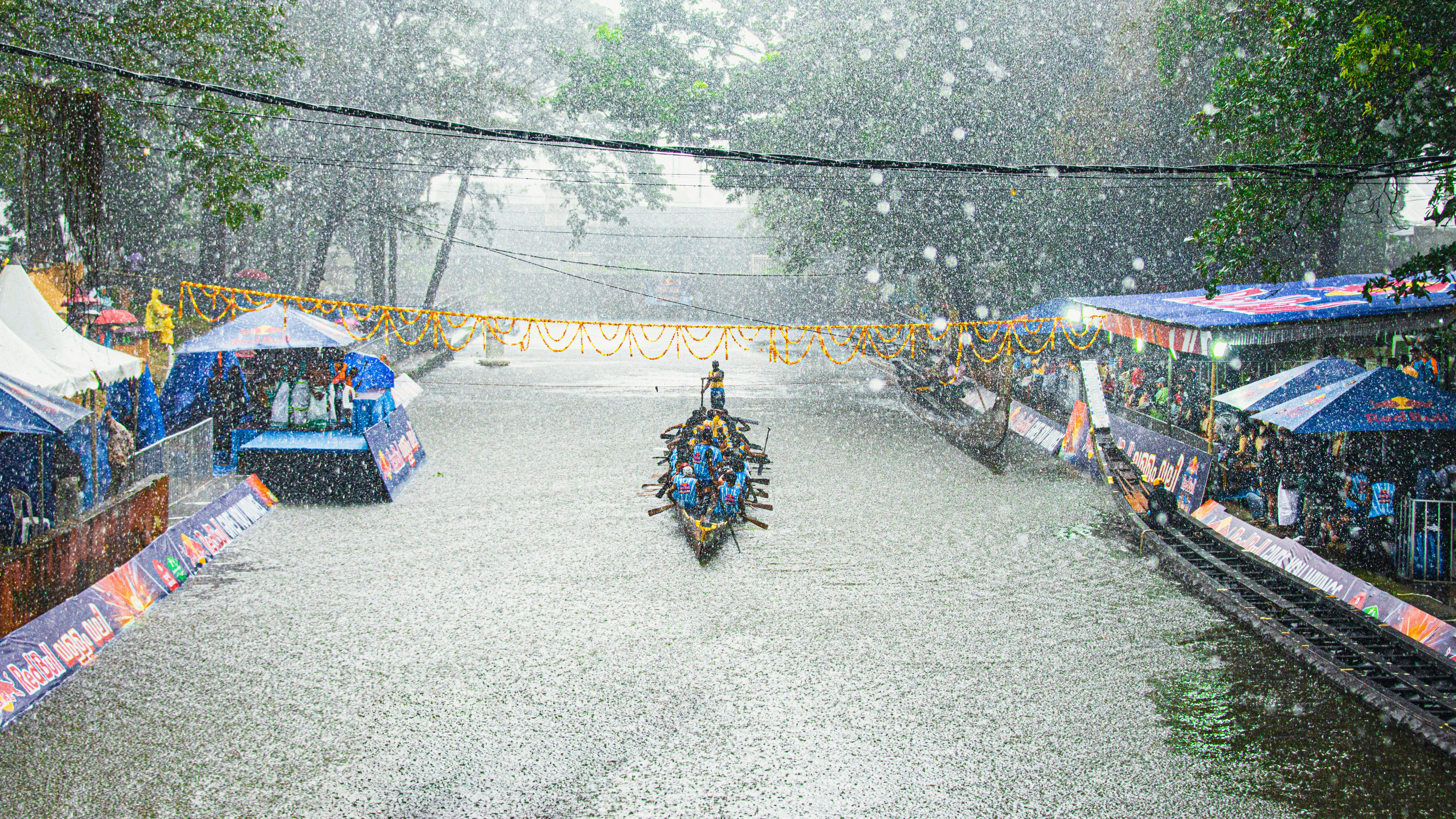 Midriver flotilla under snowfall of festival confetti