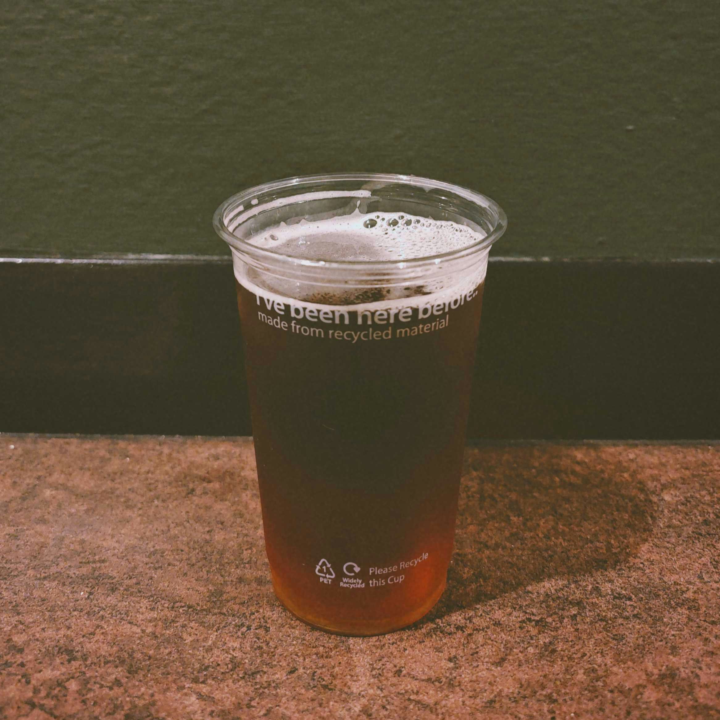 A plastic cup filled with dark beer photo – Free Sustainability Image ...