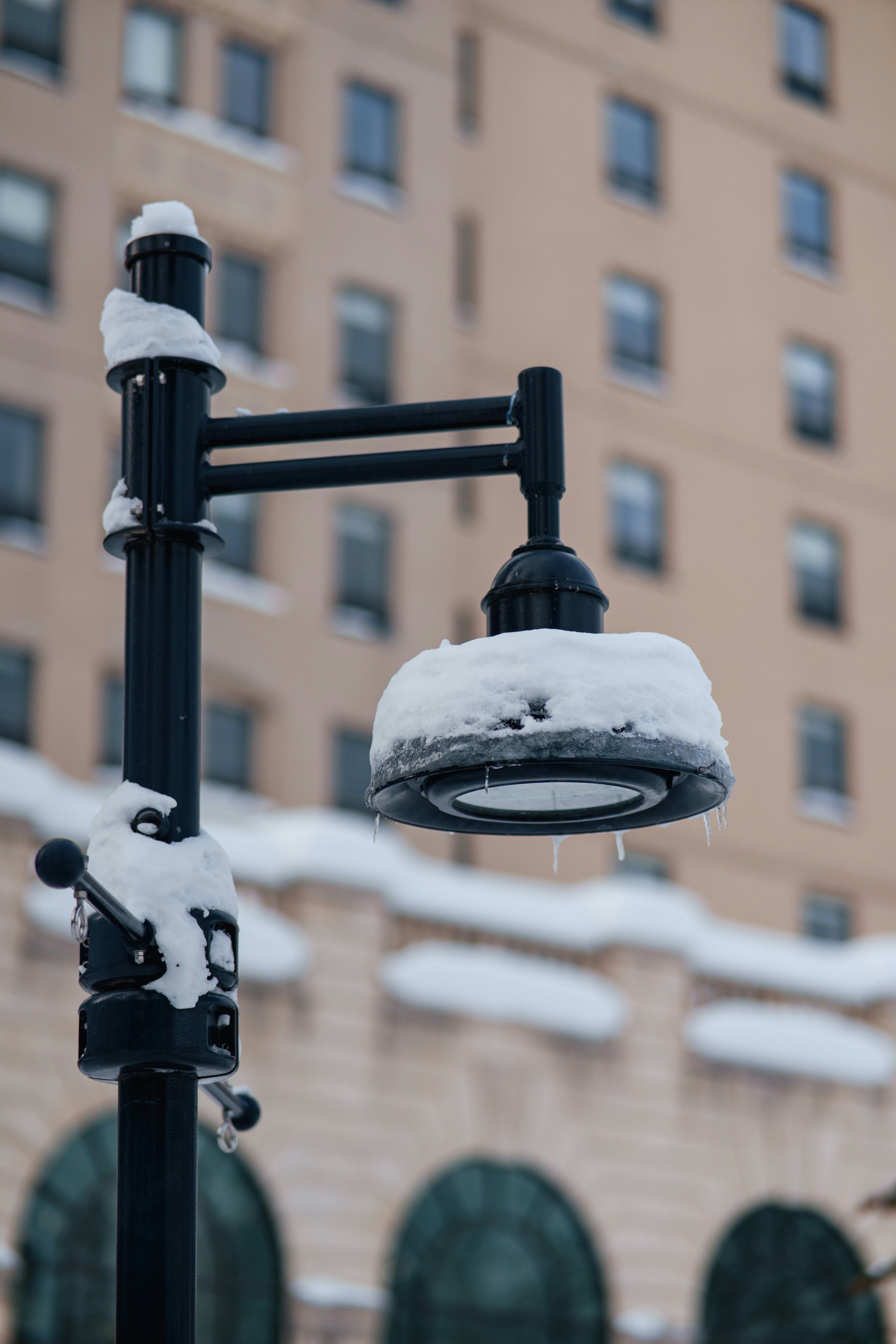 Snow-Capped Street Lamp in Quiet Winter Courtyard