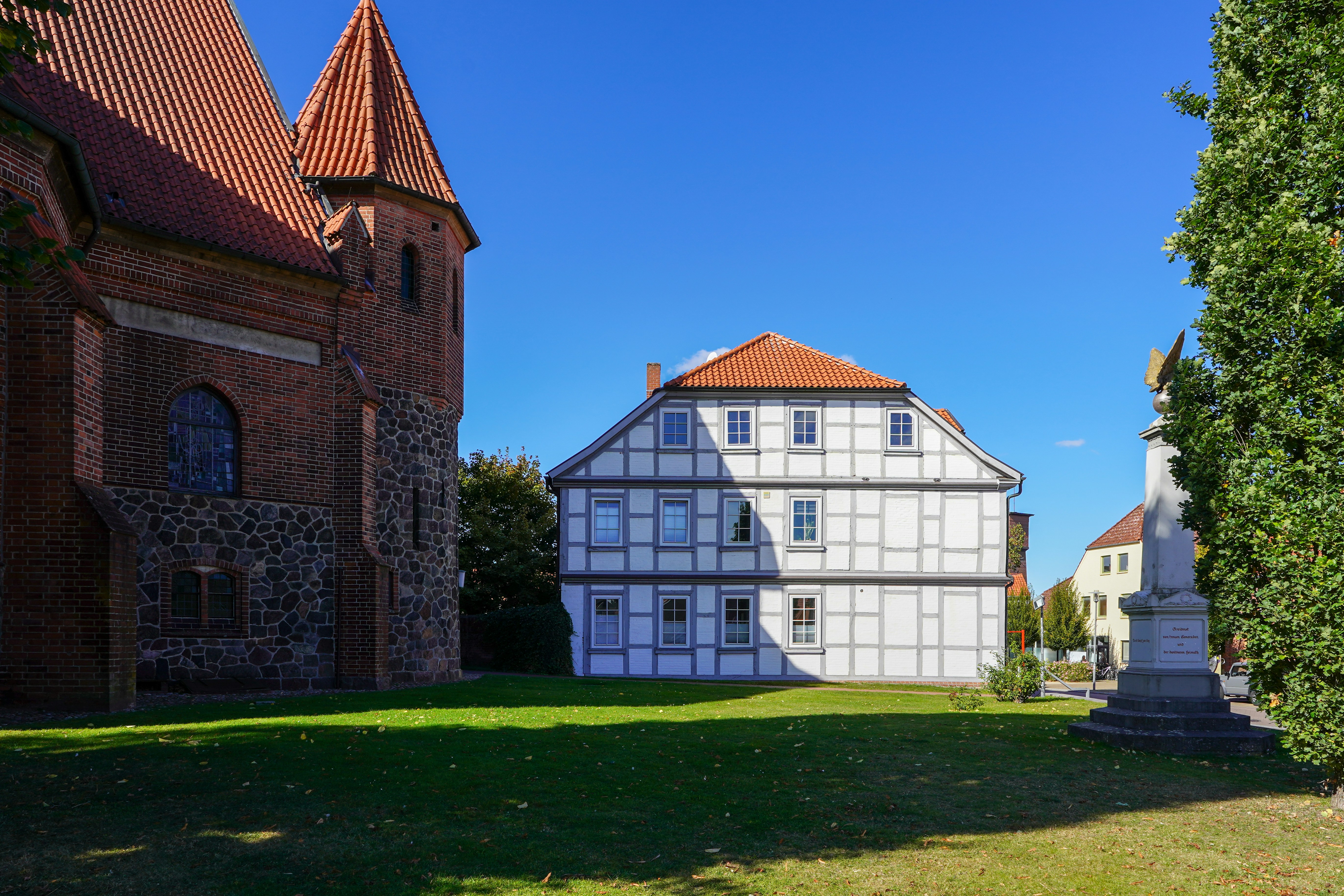 Timbered Charm: A Tudor House Framed by a Stone Church
