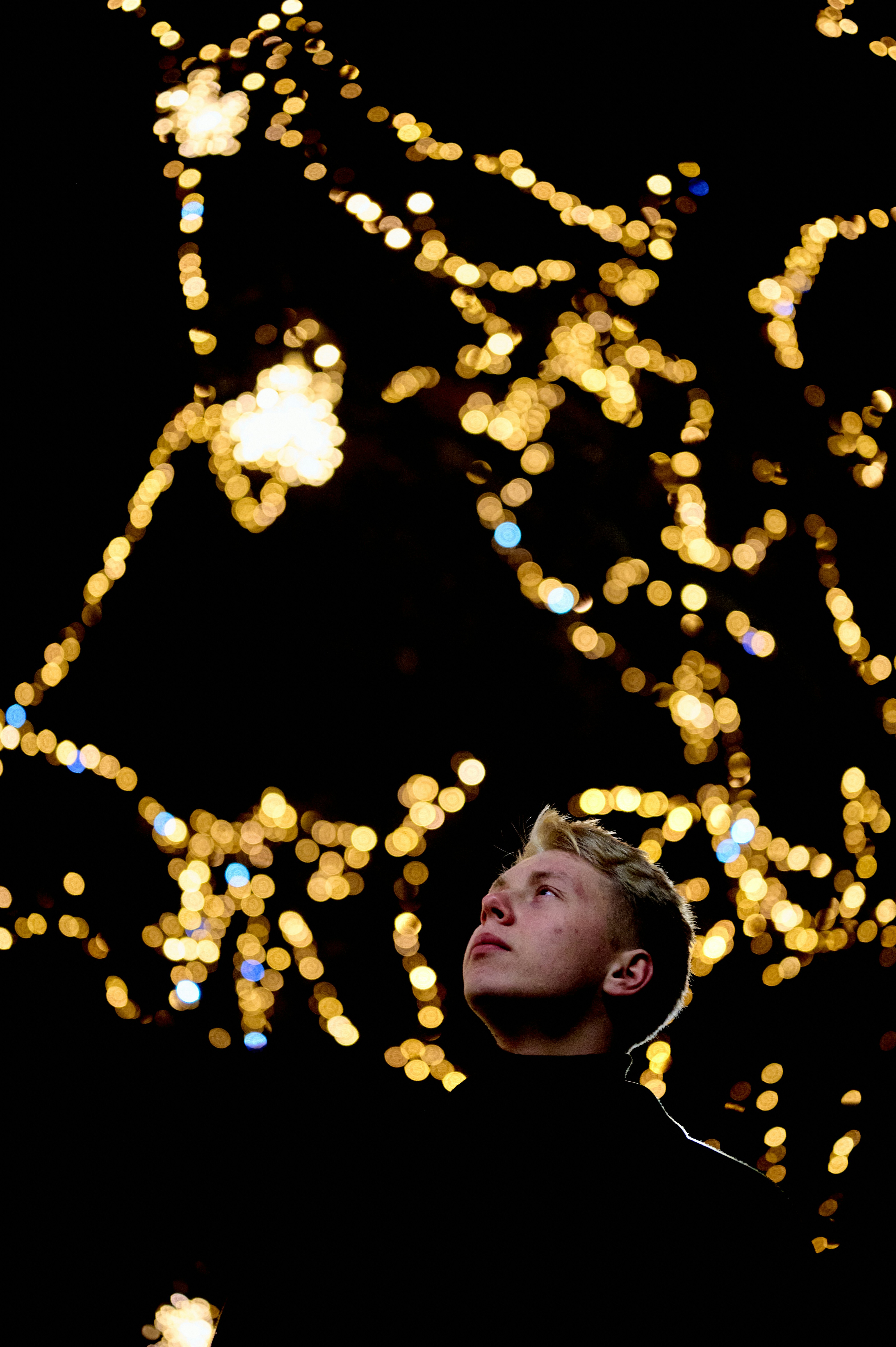 Gaze Toward the Glow: A Portrait Beneath Stringed Lights