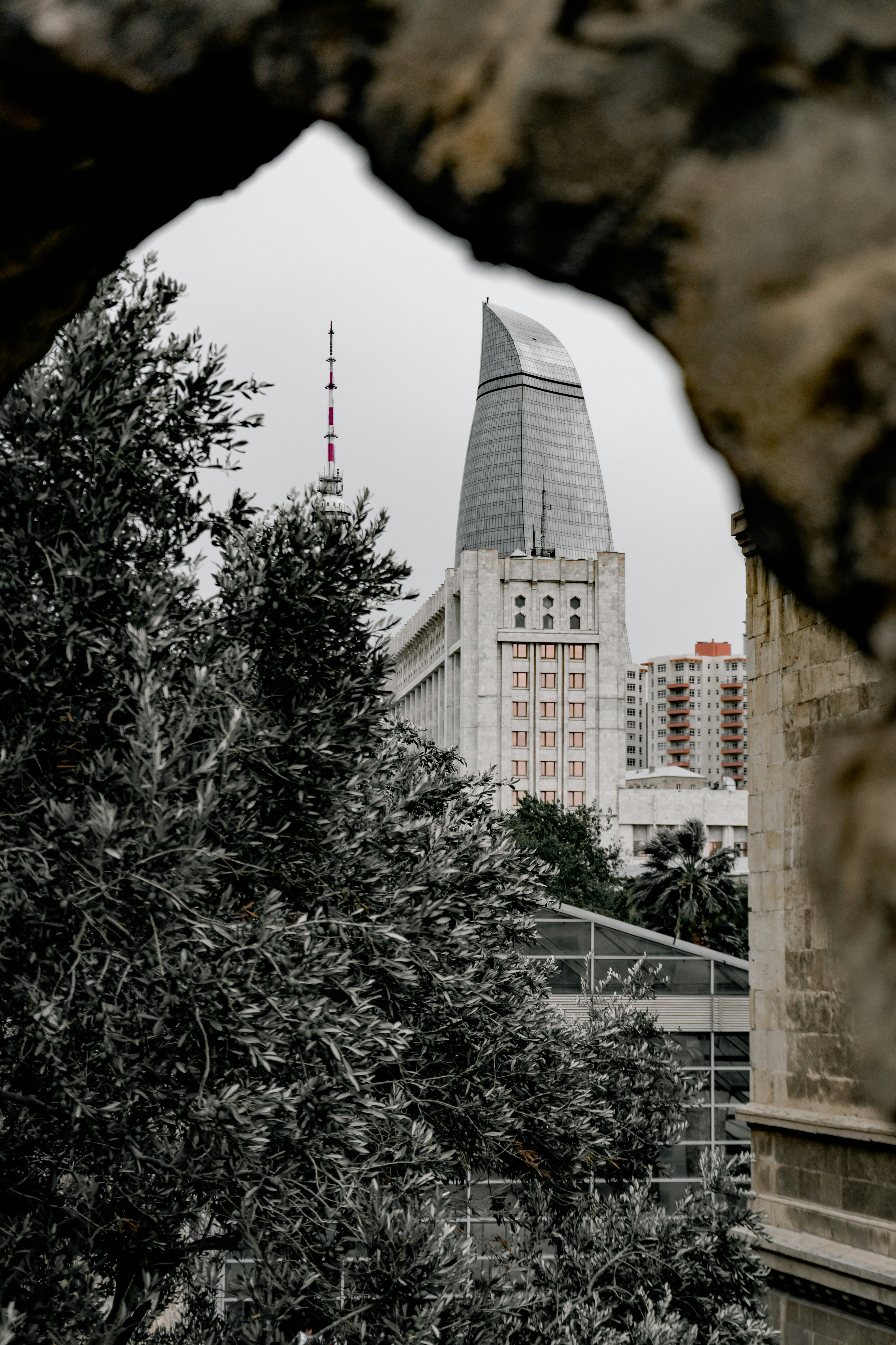Through the Arch: City Skyline Framed by a Natural Window