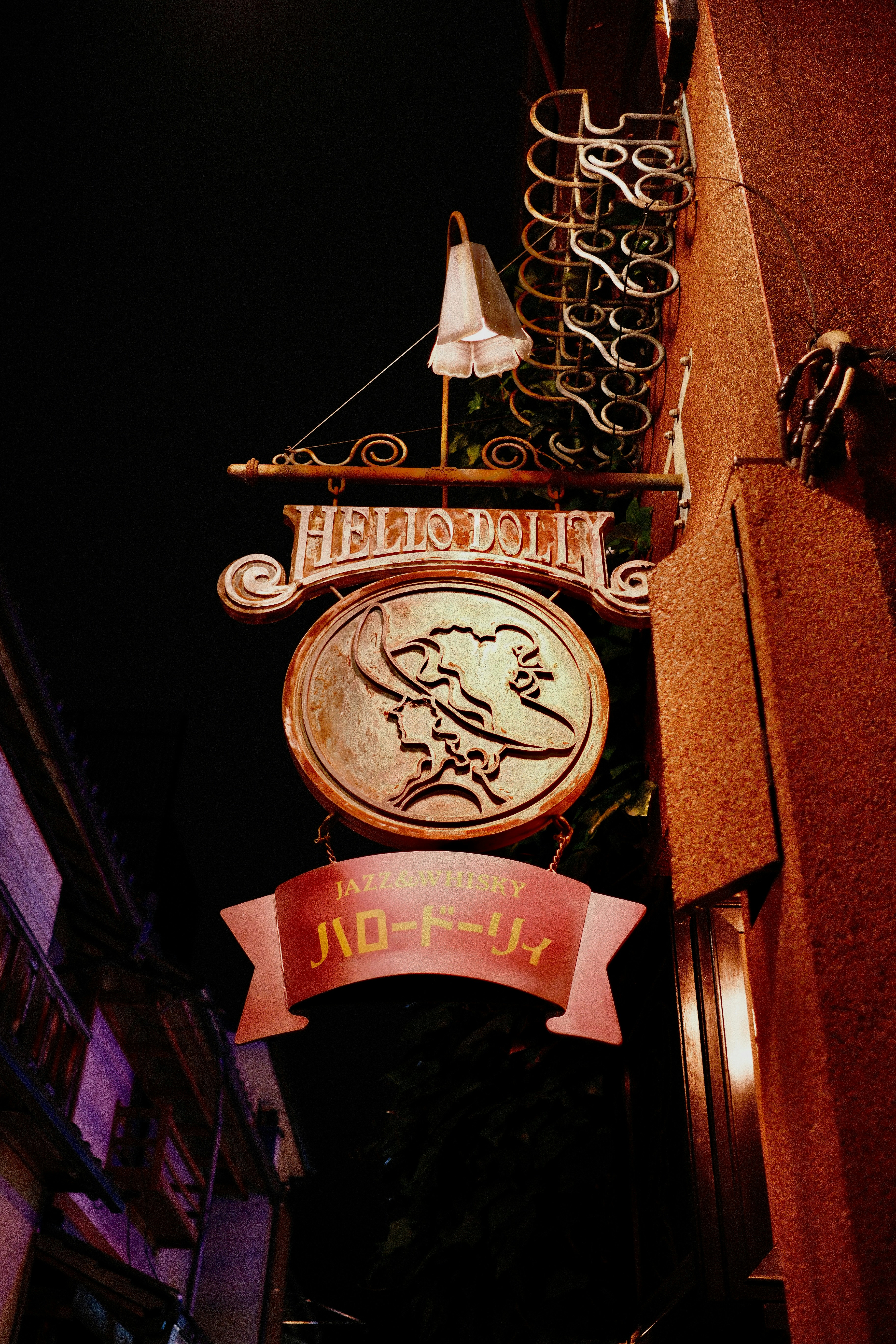 Neon Sign of Hello Dolly Jazz & Whisky under Night sky