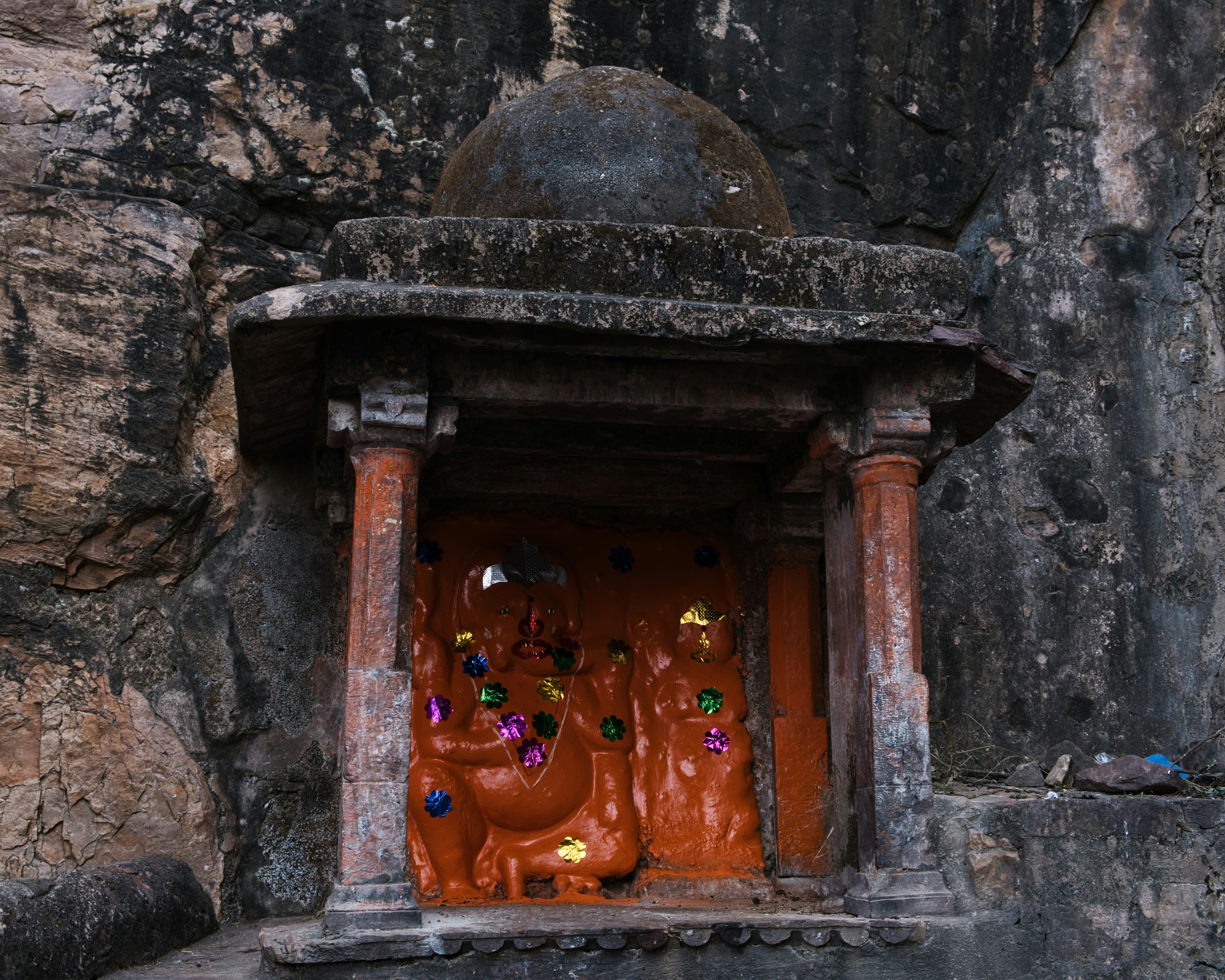 Small shrine with deities carved into rock photo – Free Worship Image ...
