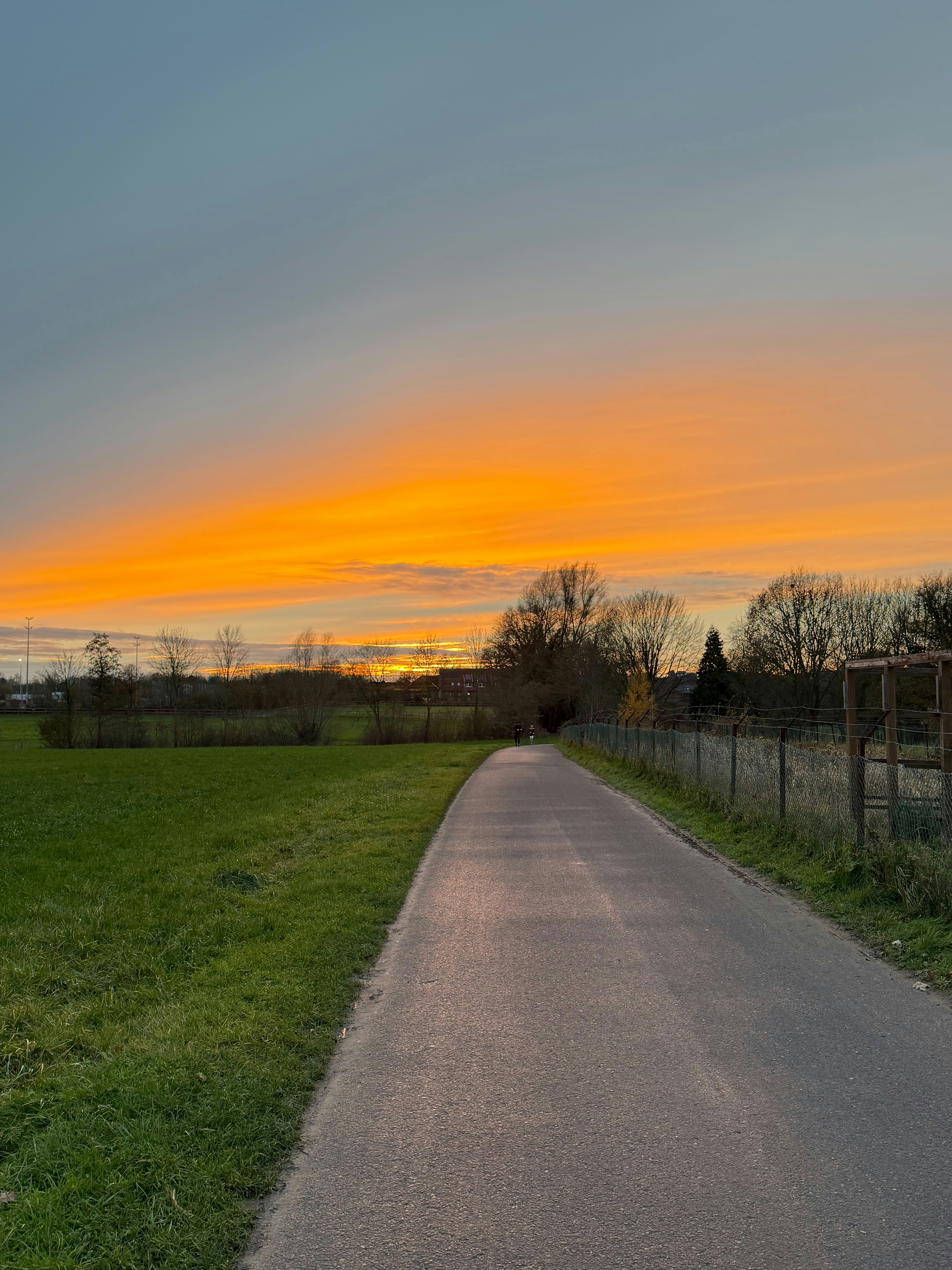 Sunset Roadway: A Quiet Corridor Toward Distant Farms