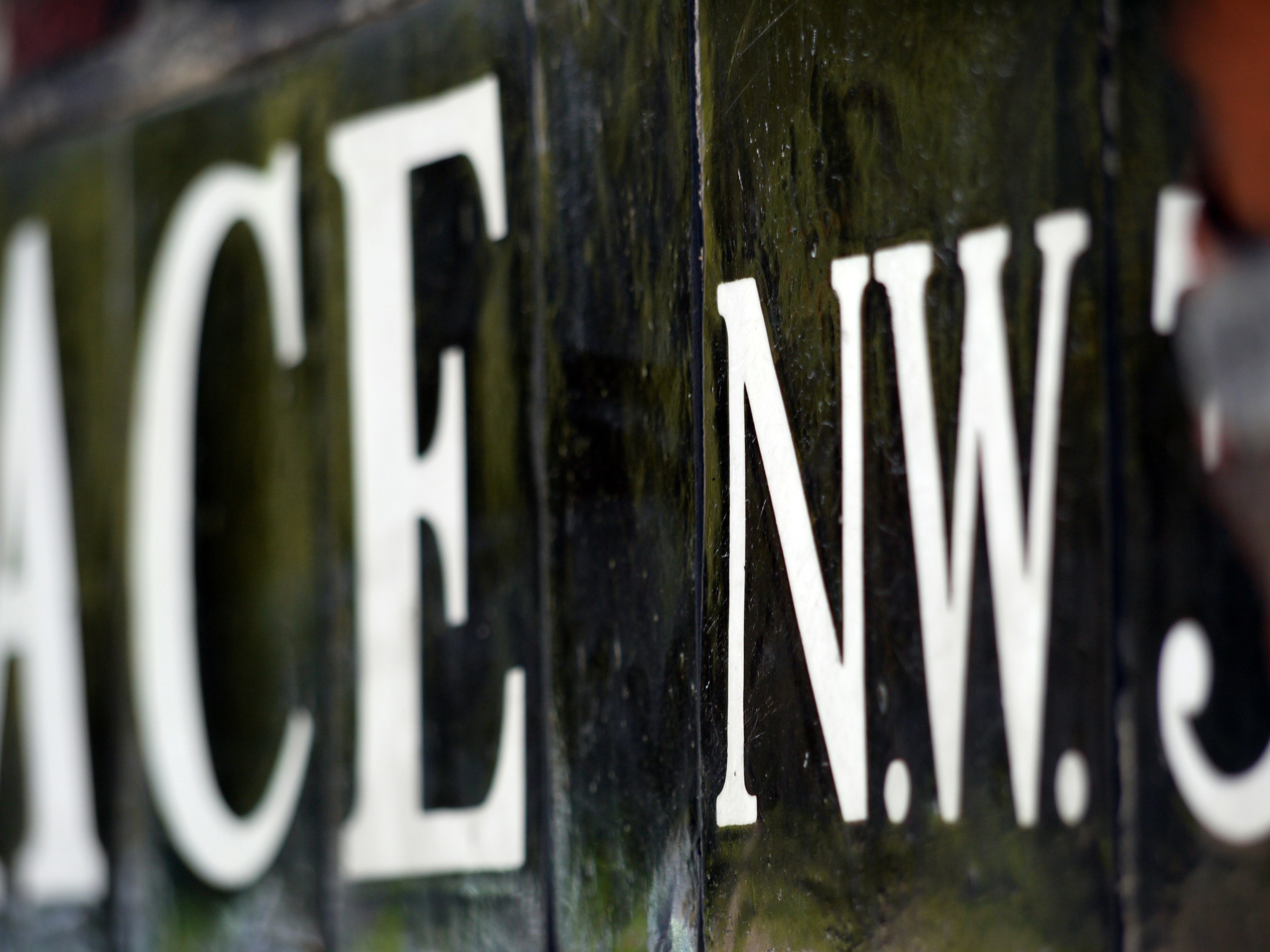 White text on dark sign reads "ace nw. 3"