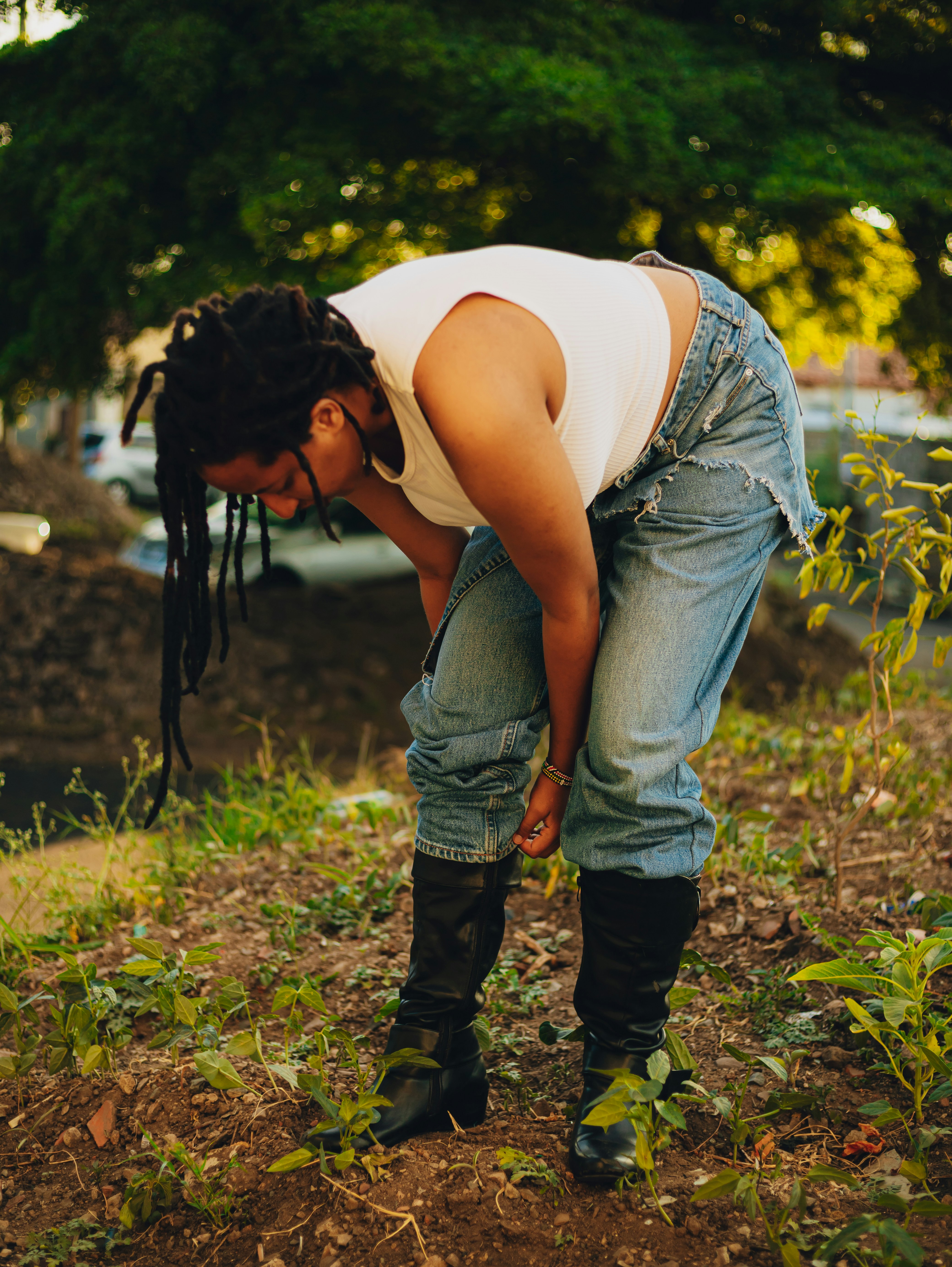 Bent-Over Garden Moment: A Dressed-Down Worker Tending Tiny Greenery