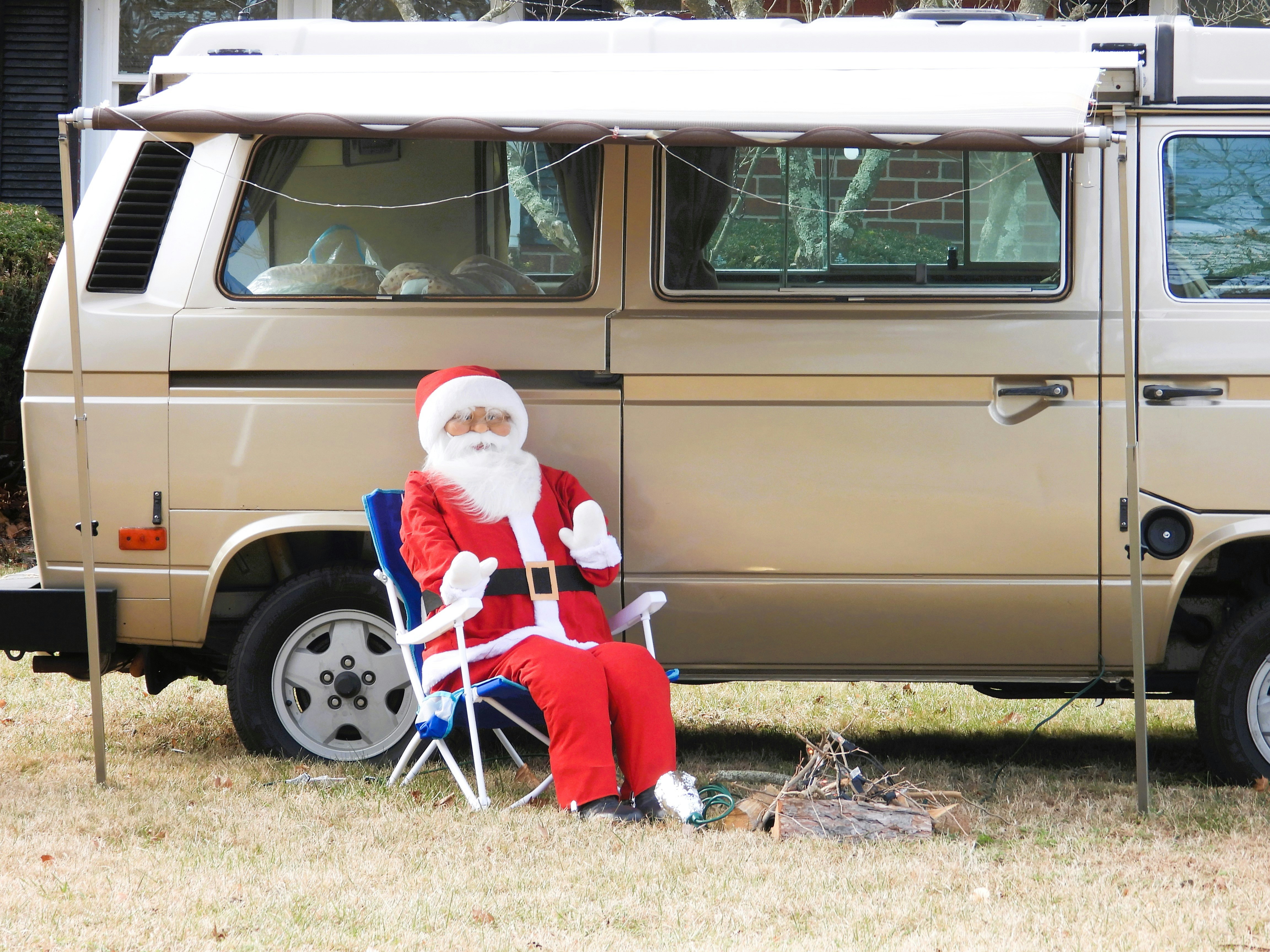 Santa Claus sitting in a chair getting ready for Christmas day.