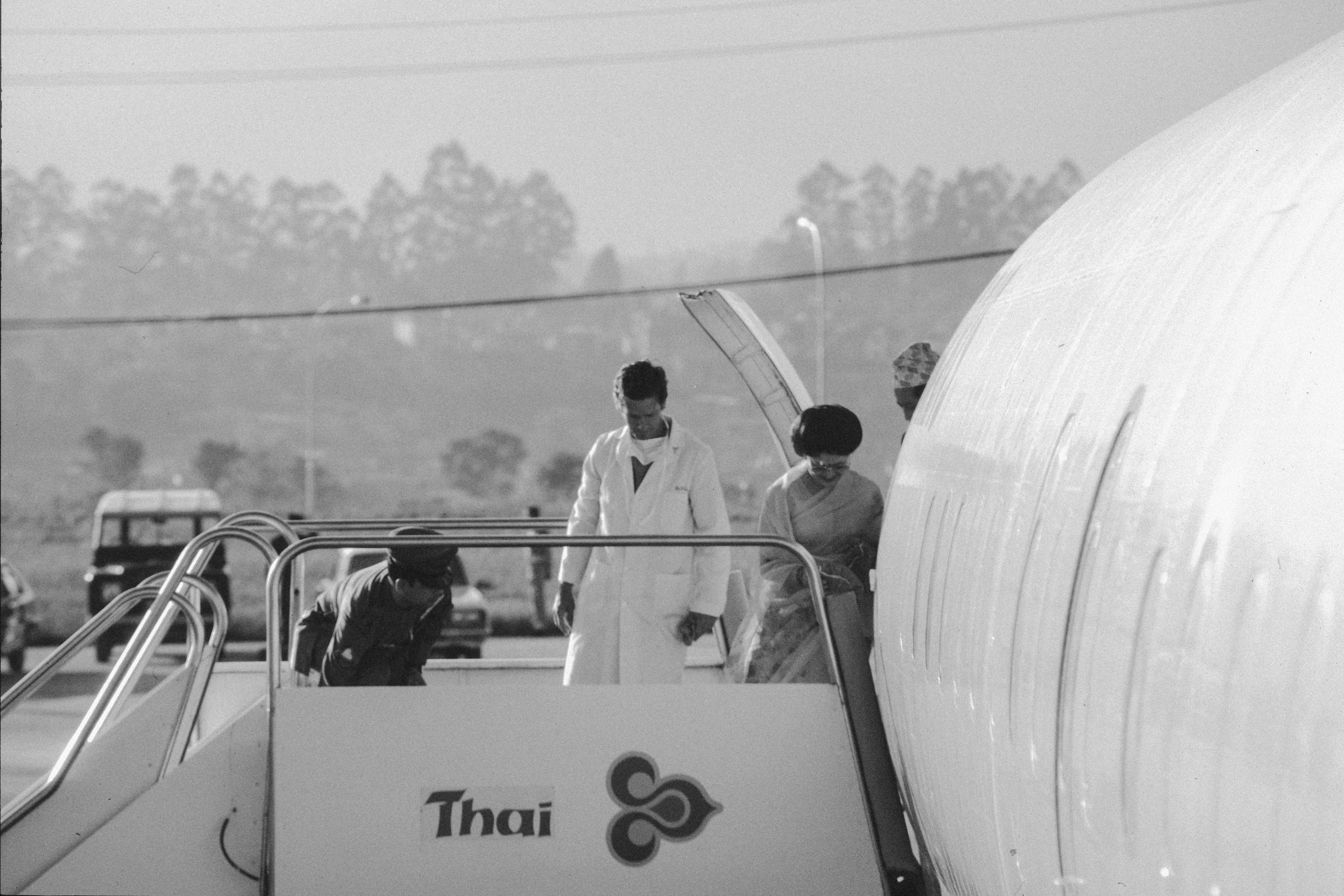 Ground Crew at the Aircraft Staircase by the Thai Airplane