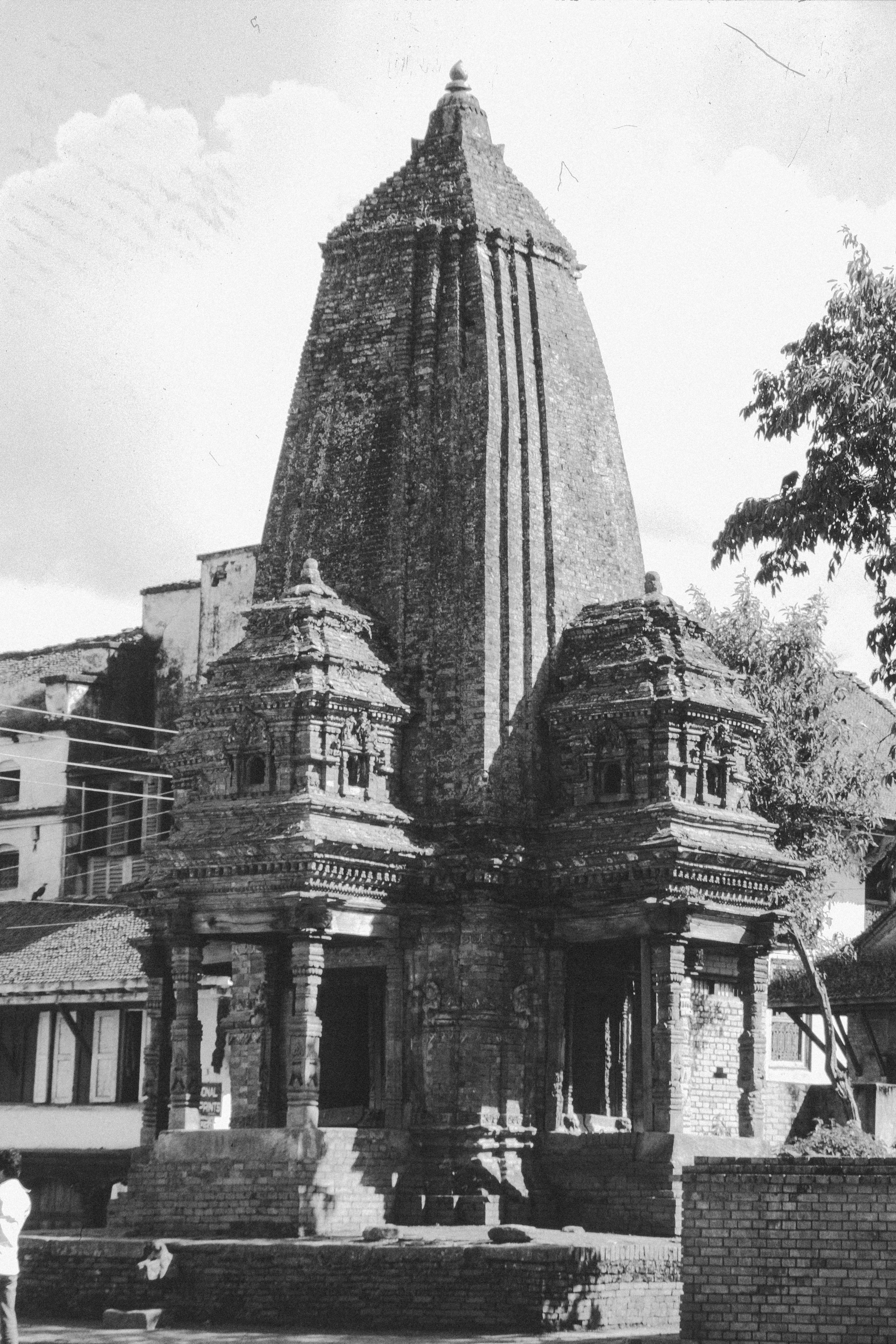Ancient brick temple with intricate carvings and tiered roof.