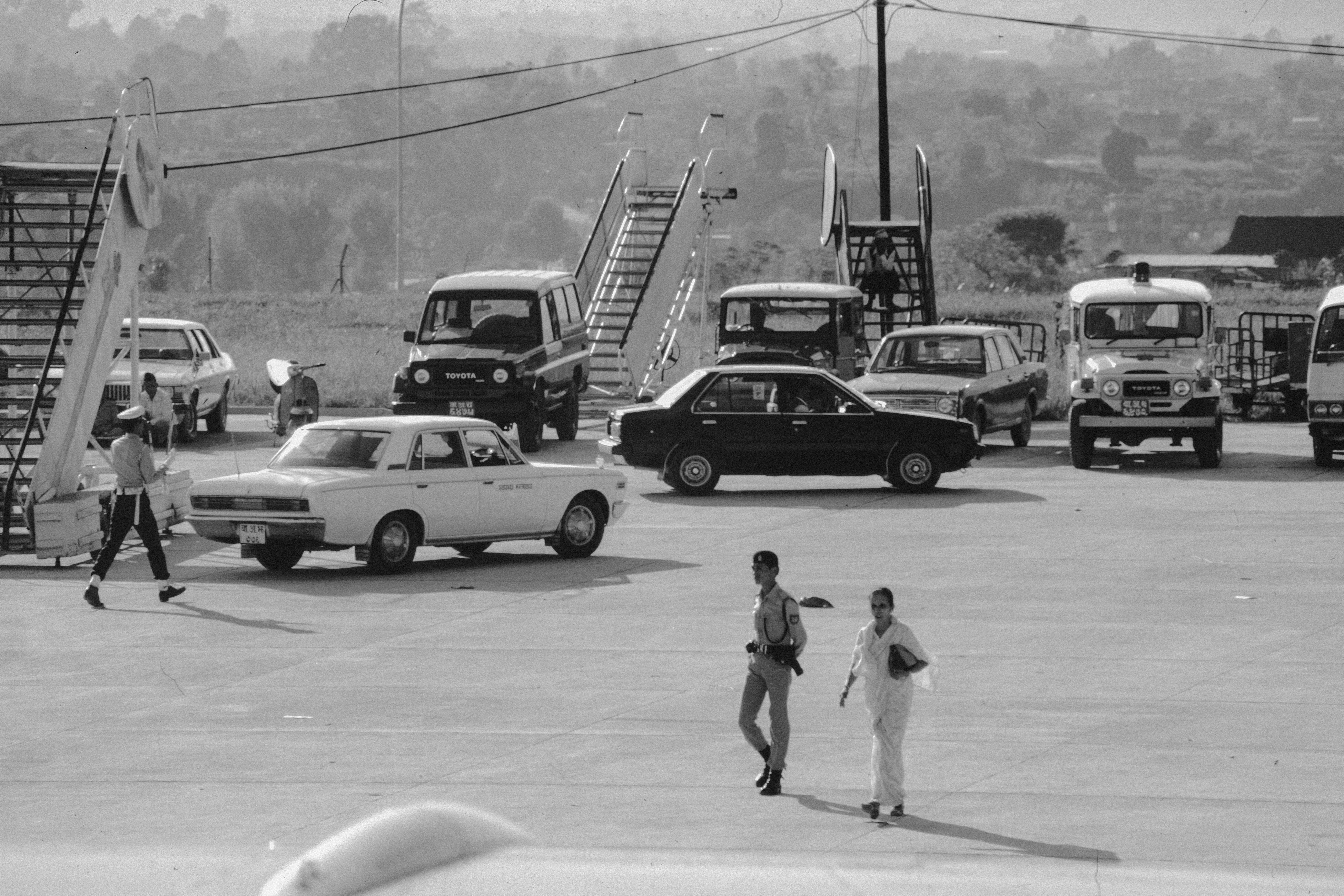 Airport Forecourt: Vehicles and Travelers in a Quiet Moment