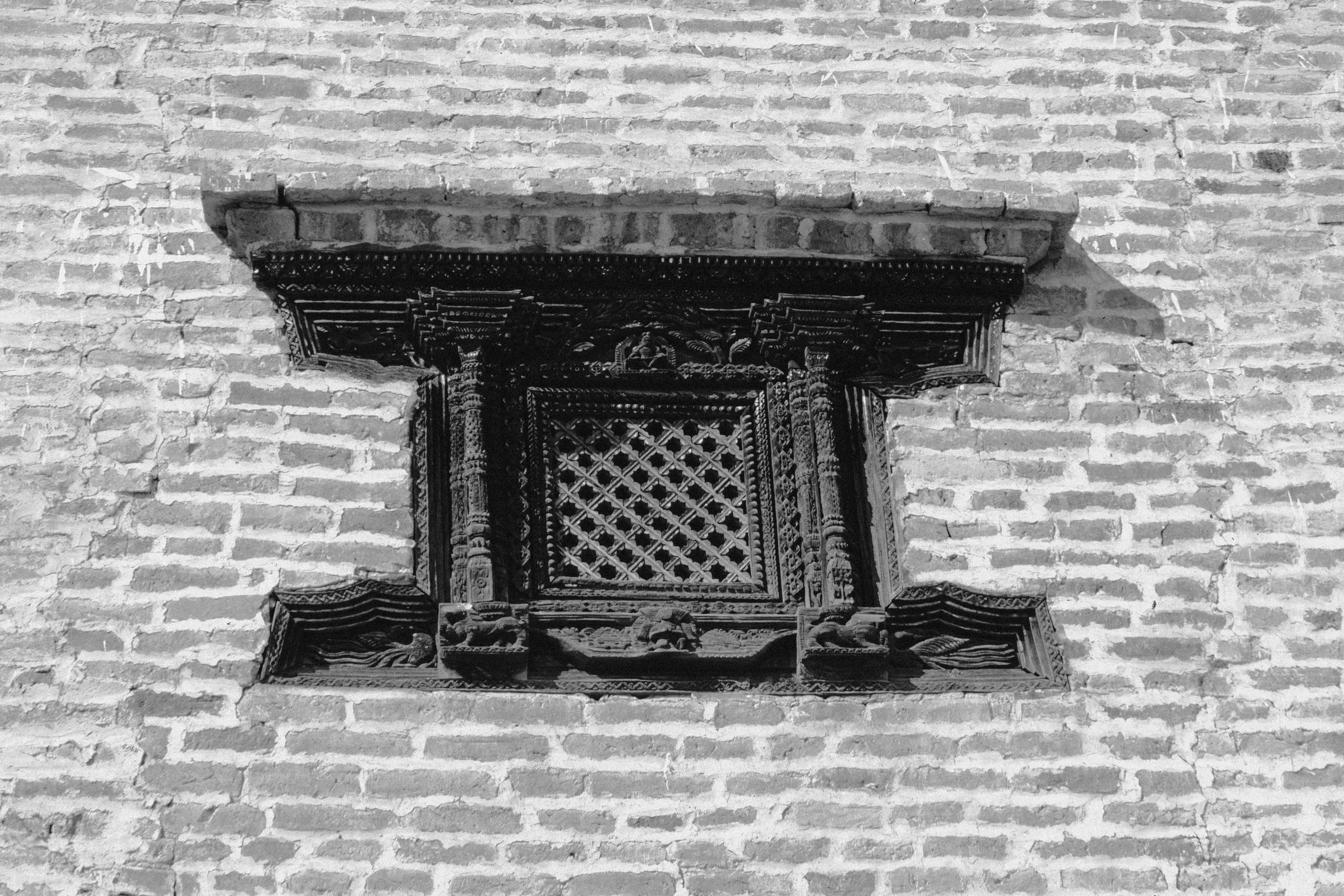 Stone Lattice Window Framed by Brickwork