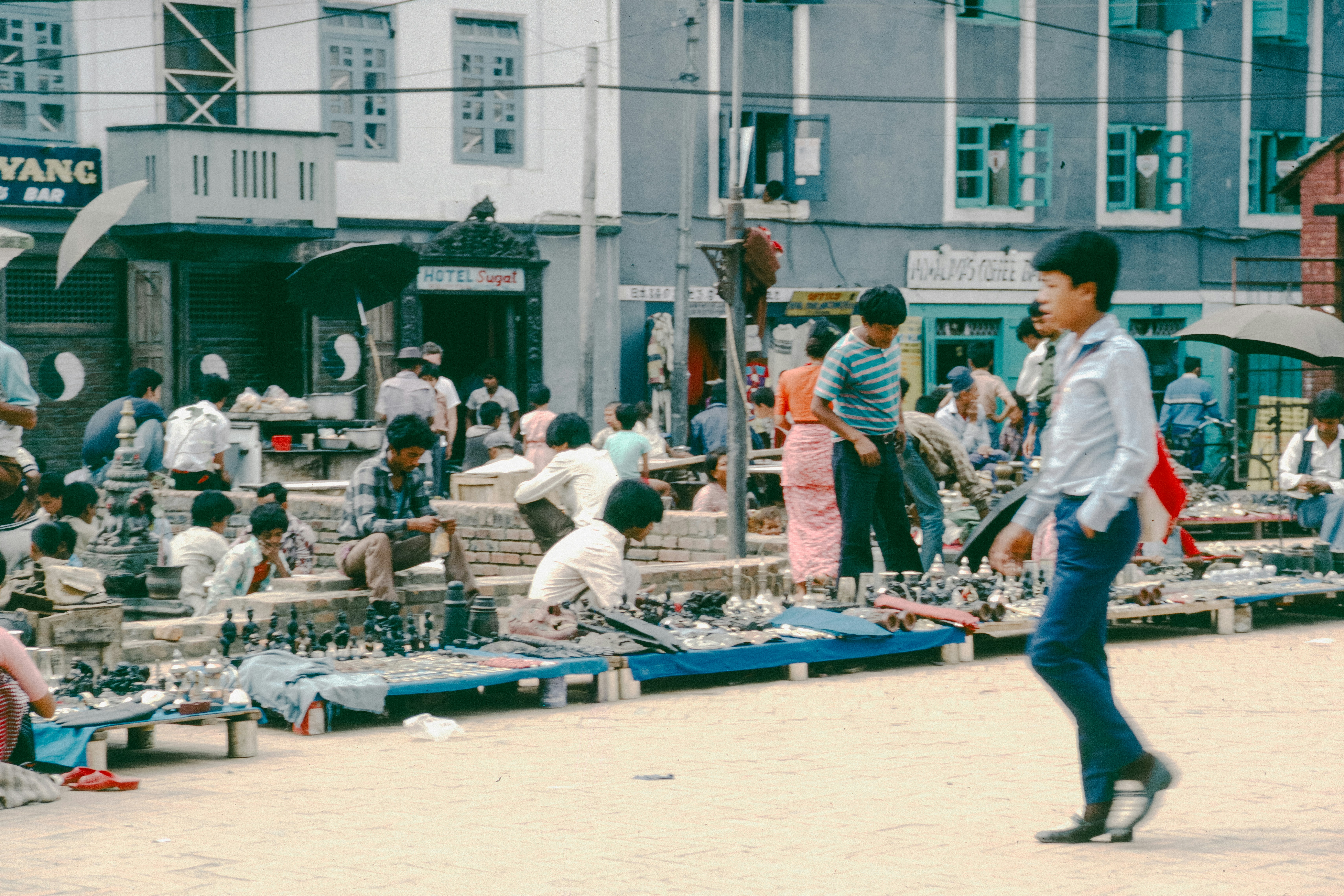 Market Stroll: Vendors, Shoppers, and a Pedestrian in Motion