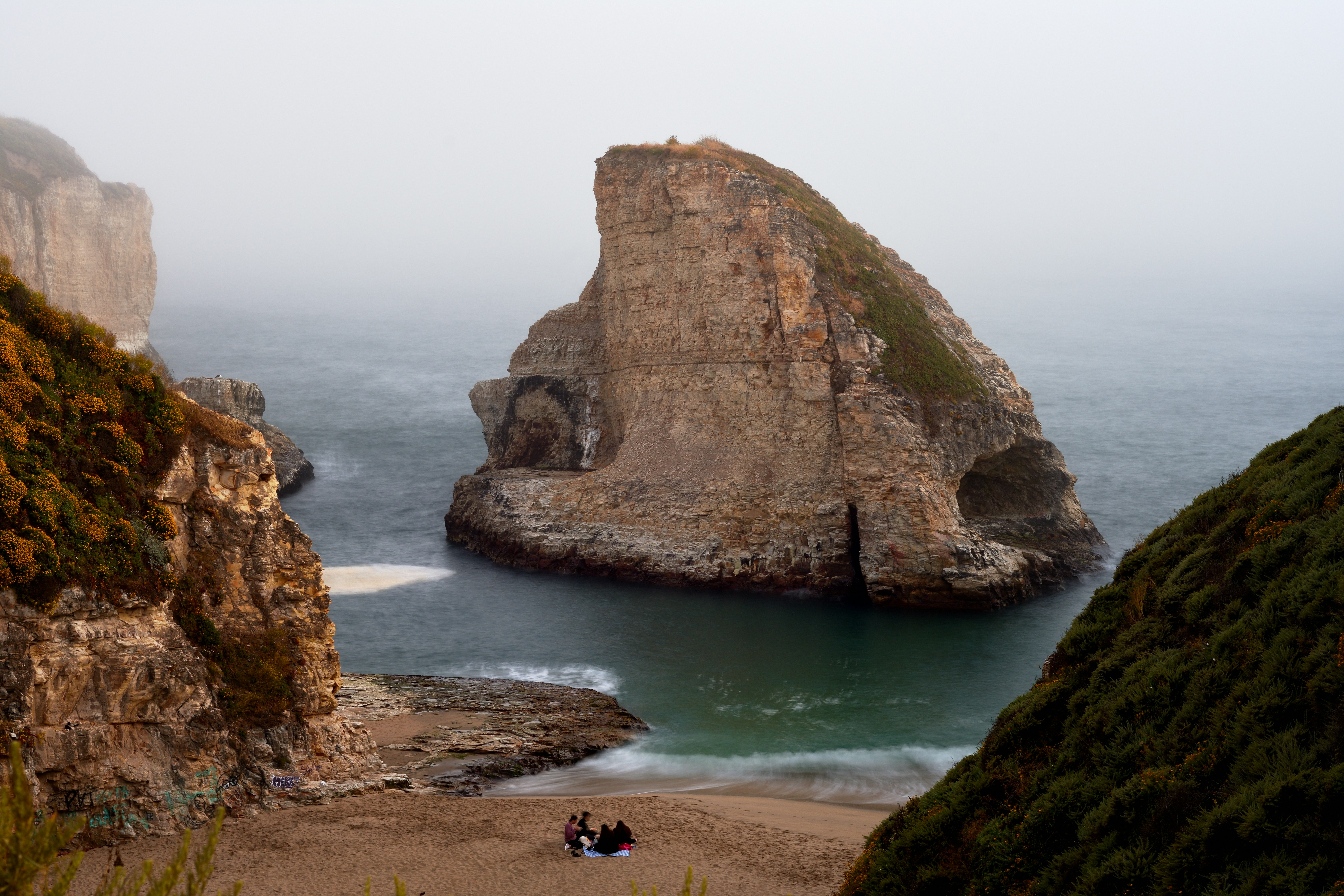 Sea-stack Sanctuary: Lone Rock Reaches Toward a Misty Horizon