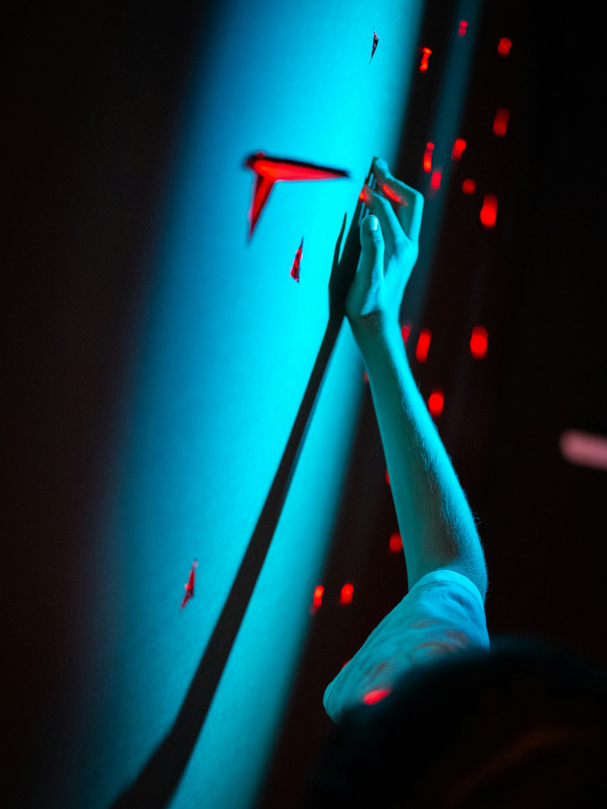Blue Neon Hands: A Moment at the Edge of the Curtain