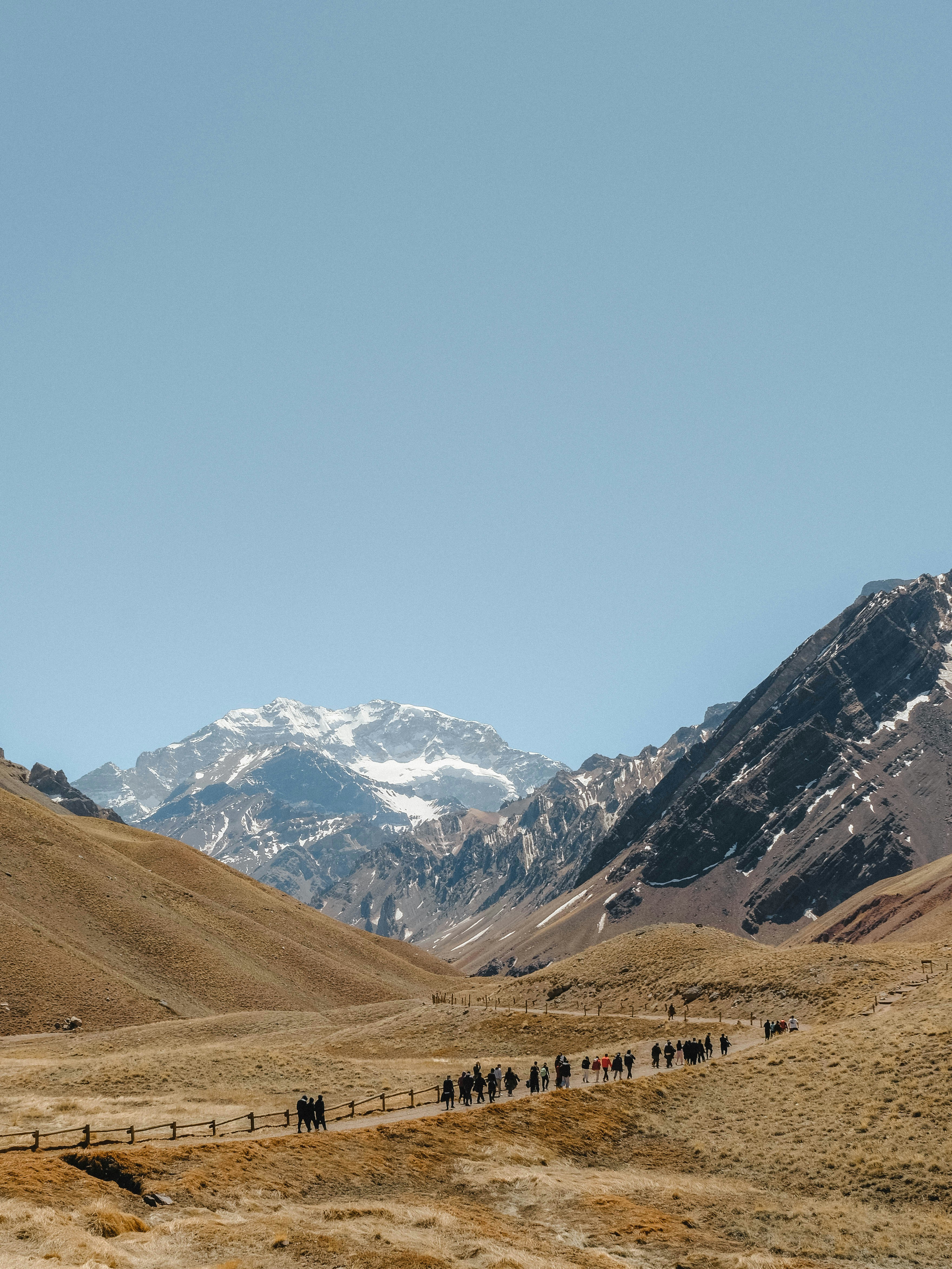 Hikers Thread the Basin toward Snow-crowned Peaks