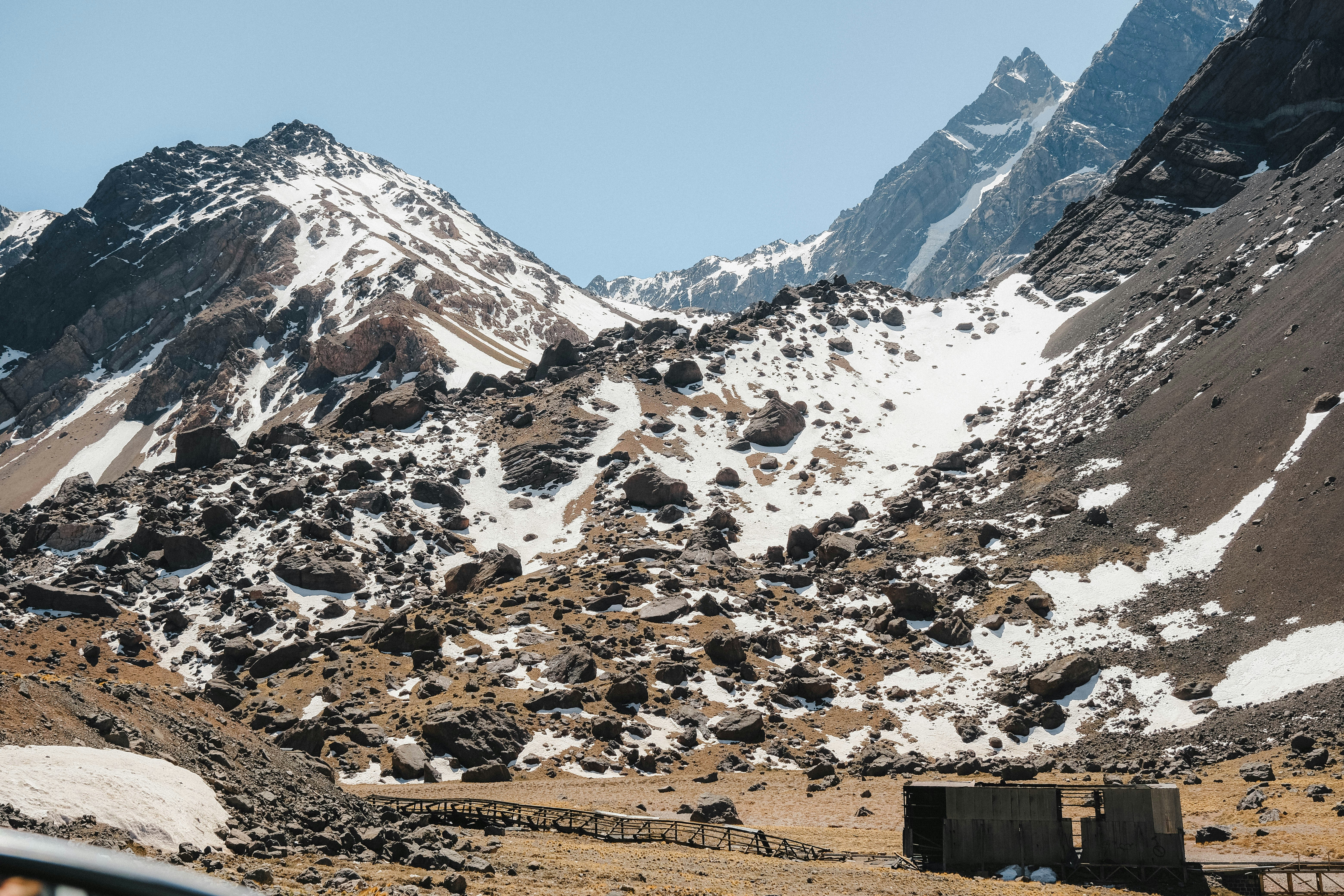 Snow-kissed Peaks Above a Rugged Tarmac
