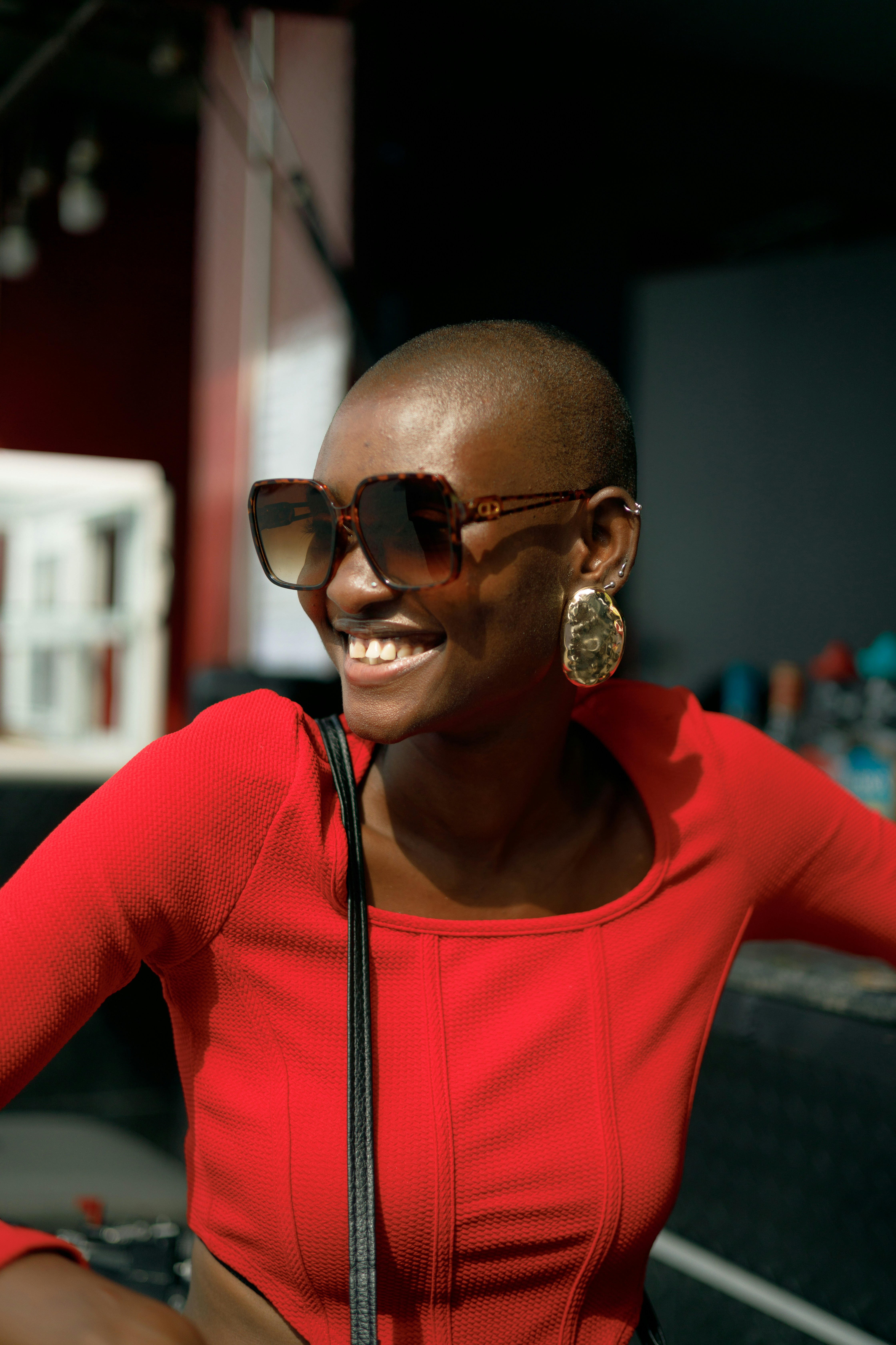 Red dress, bold smile: a confident portrait in sunlight