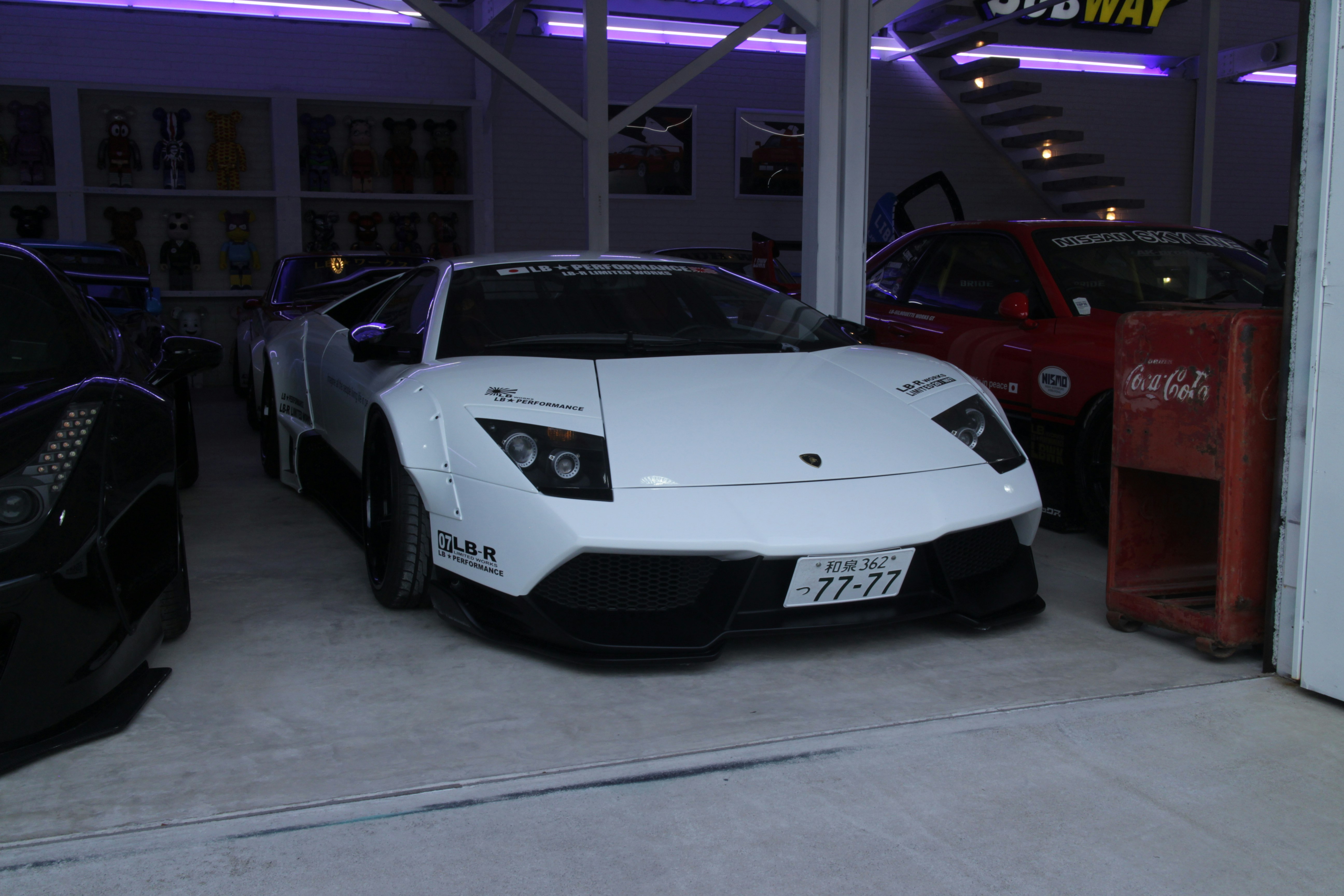 White lamborghini parked inside a garage.