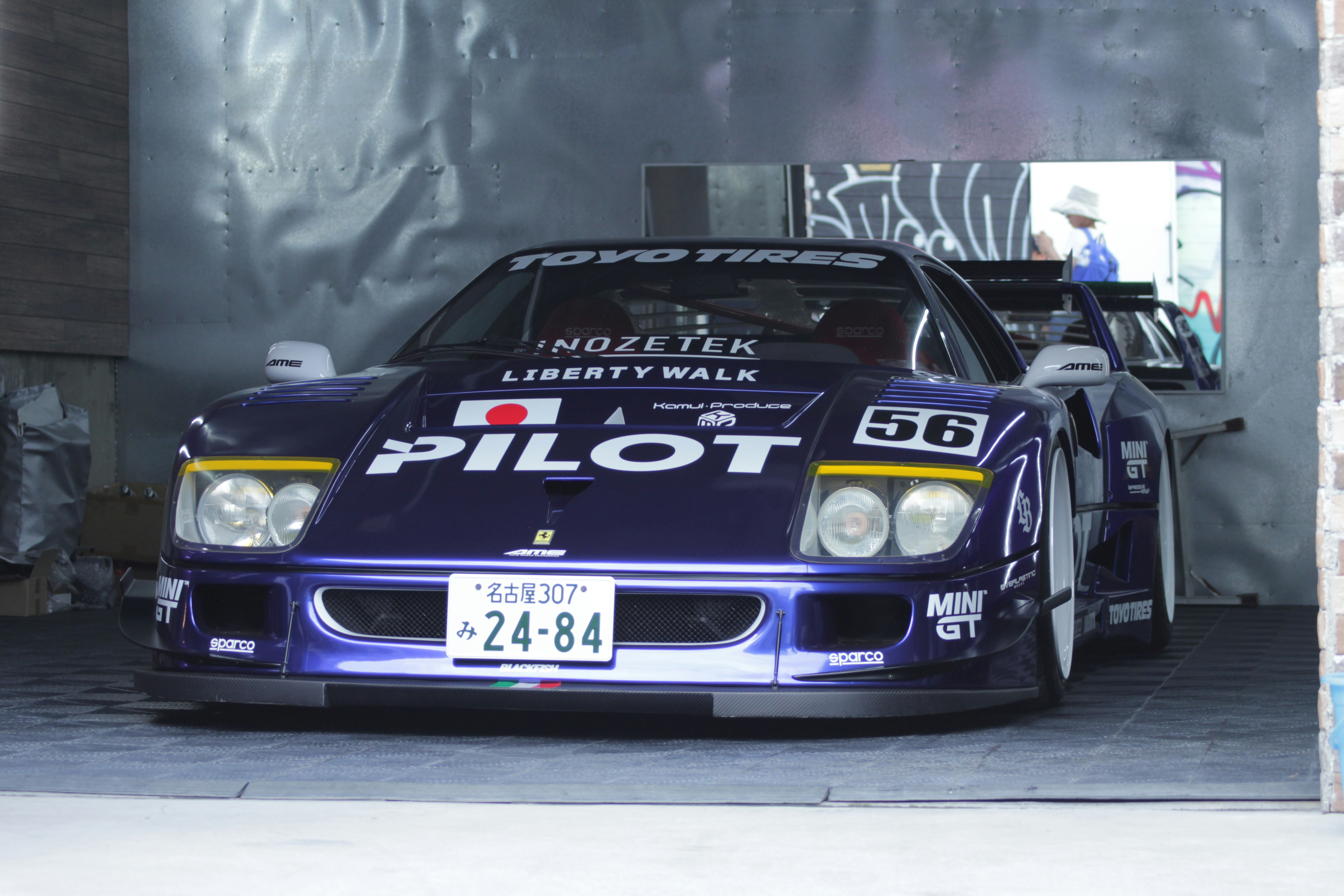 Blue Livery and Bold Numerals: Racing Thoroughbred in a Garage