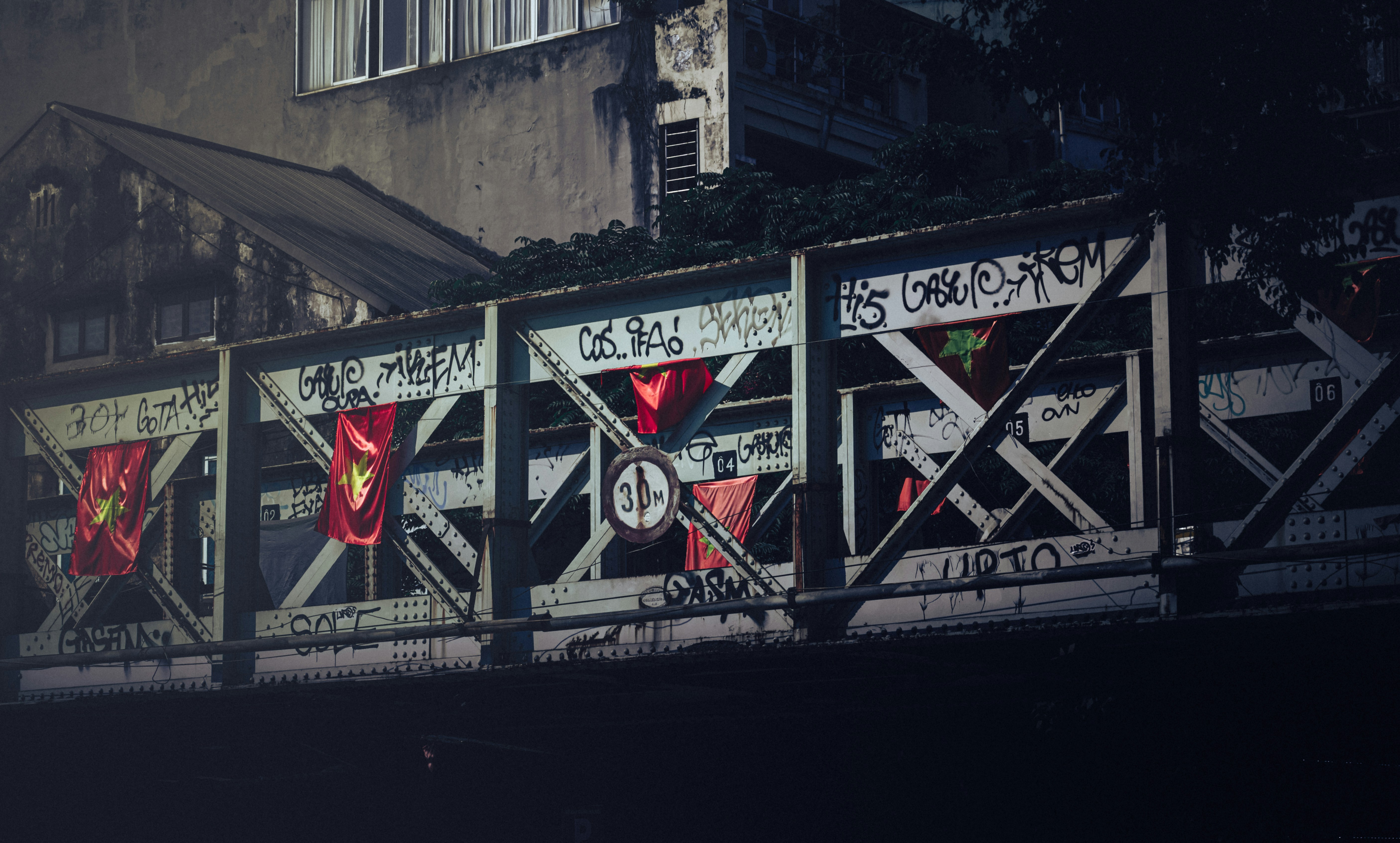 Graffiti-covered walkway under urban shade