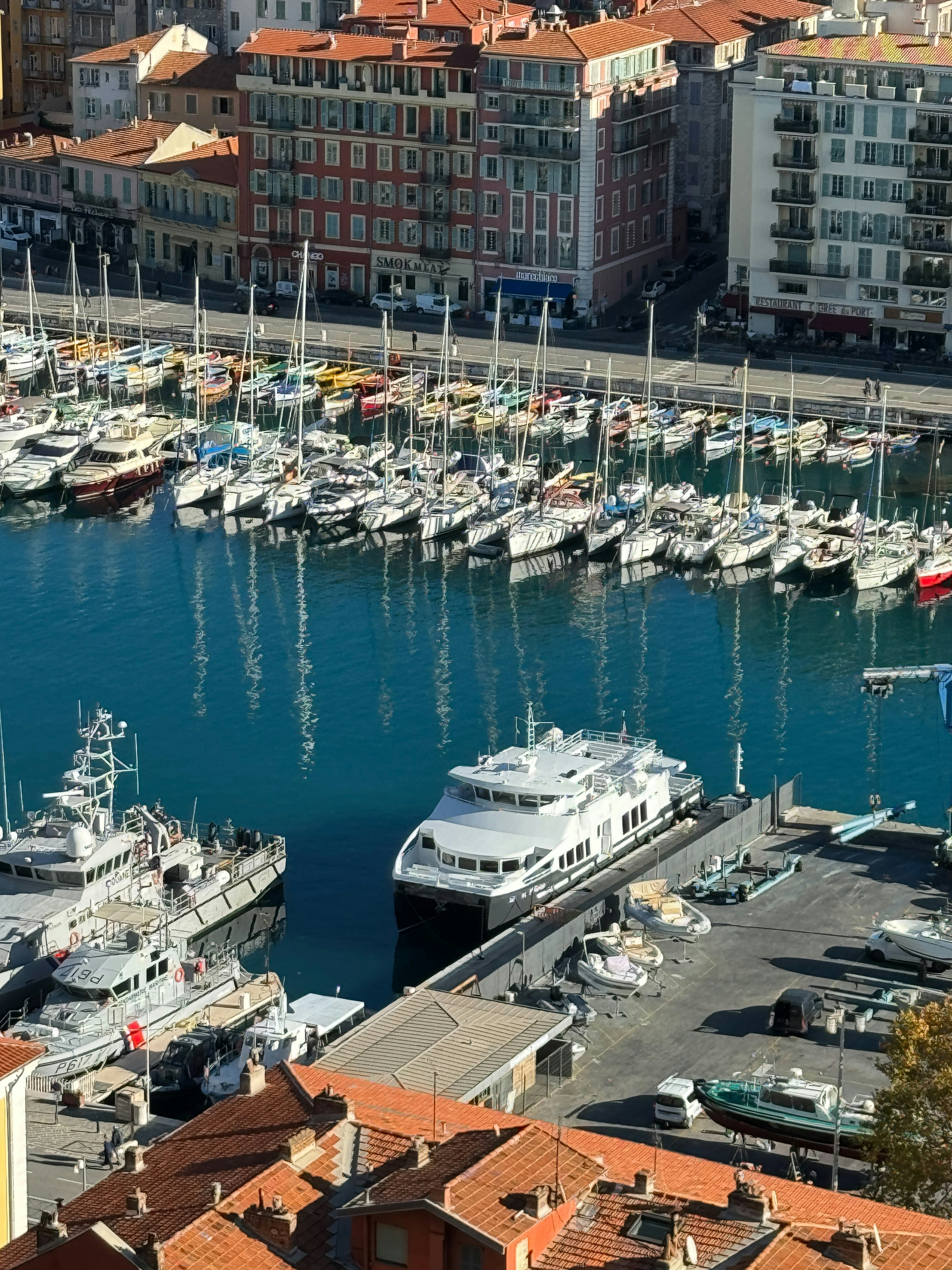 Harbor Silhouettes: Boats Dotted Along a Sunlit Italian Coastline