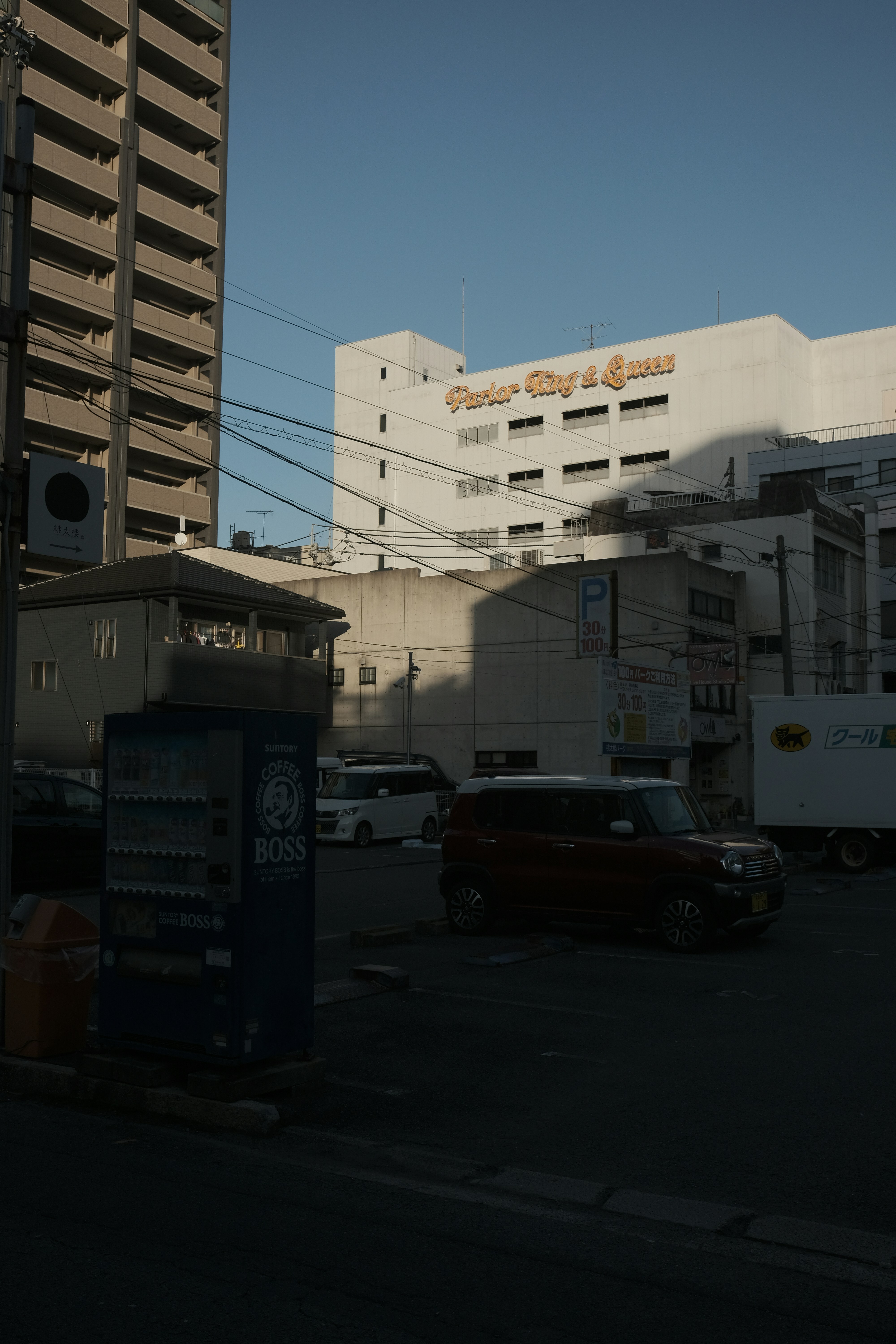Shadowed Street Corner Under a Sunlit Sign