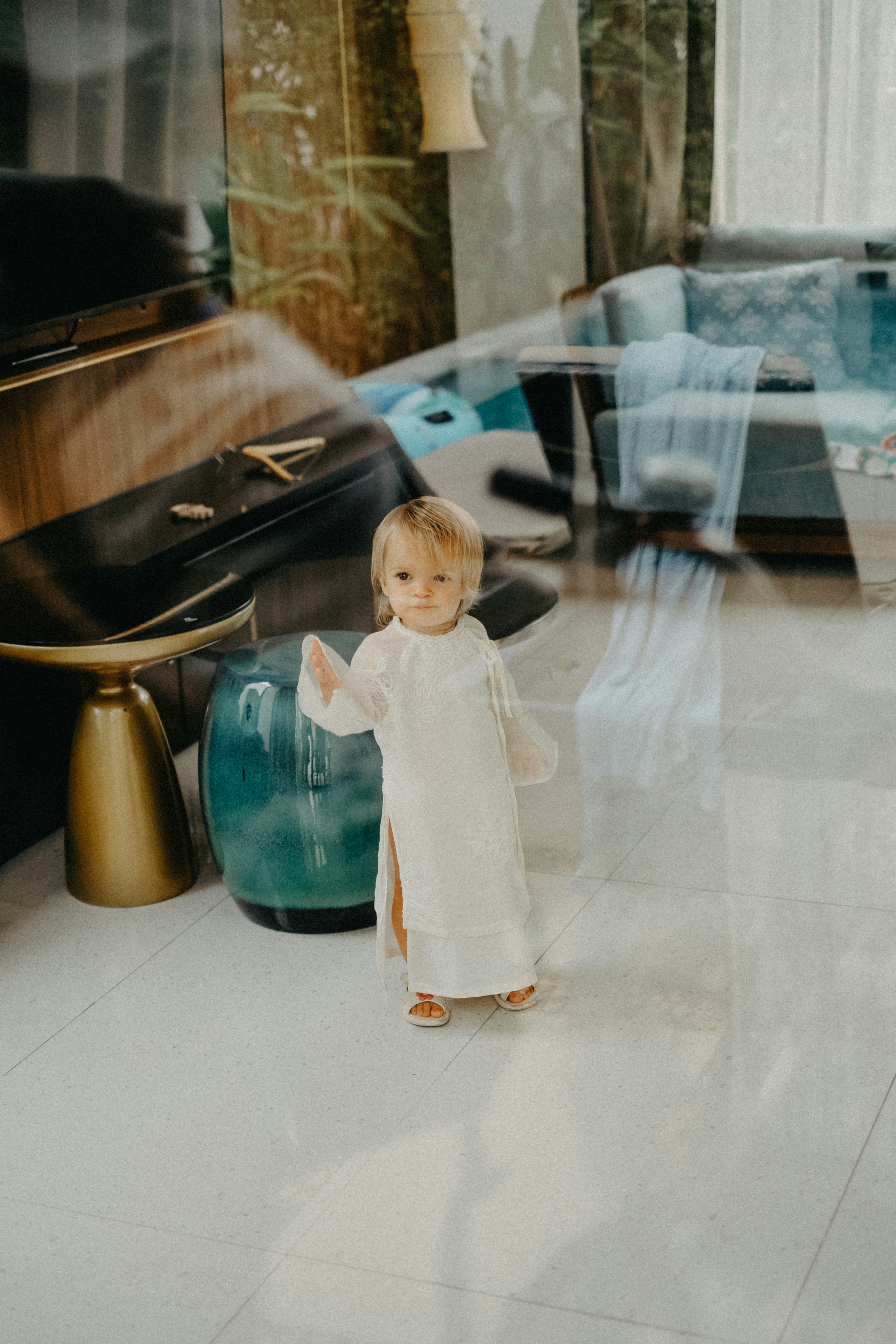Child at the Threshold: Soft Light and Reflections in a Modern Living Space
