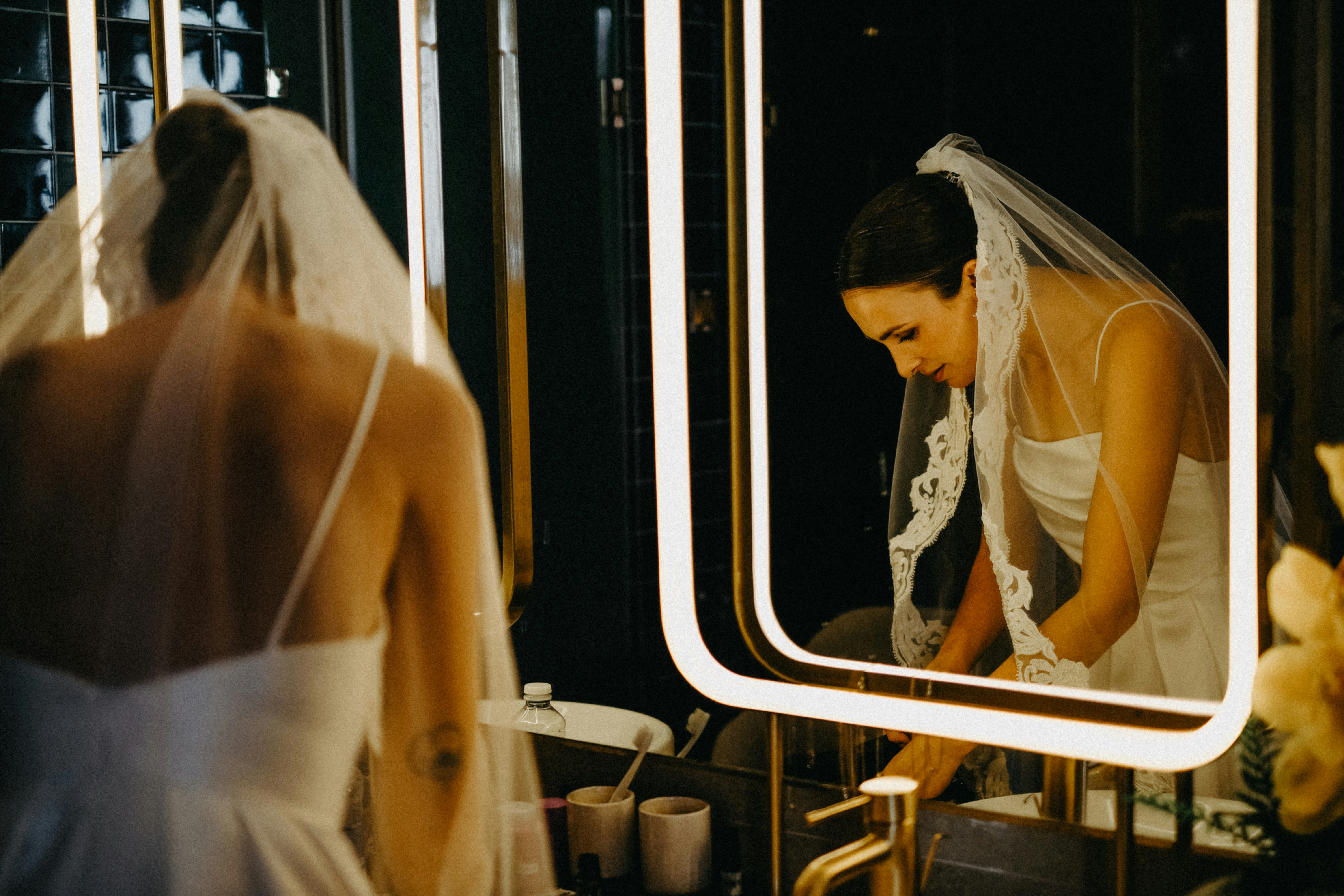 Bride Reflected: A Quiet Moment in the Glow of the Vanity Mirror
