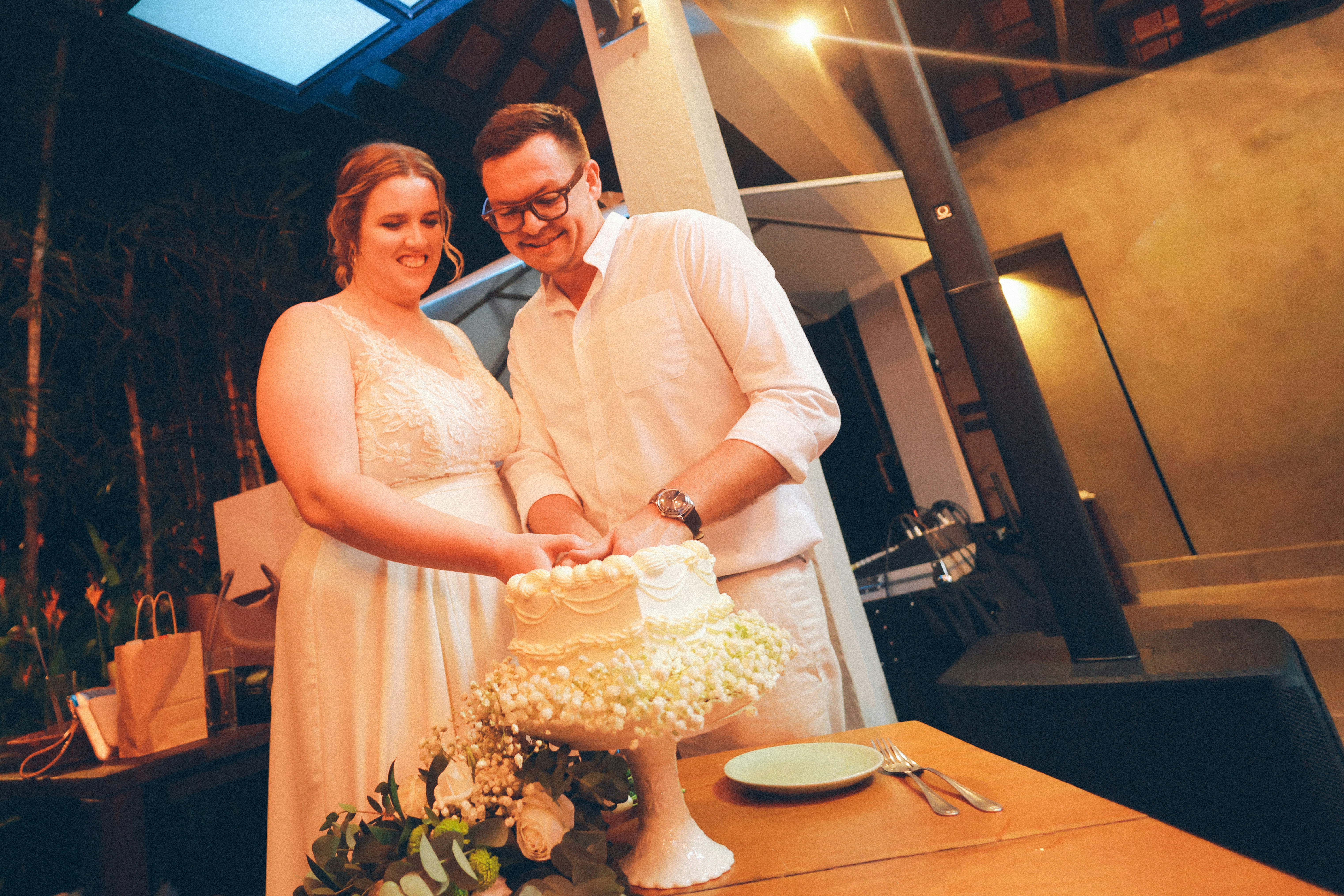 Couple Celebrates with Cake at an Indoor Reception