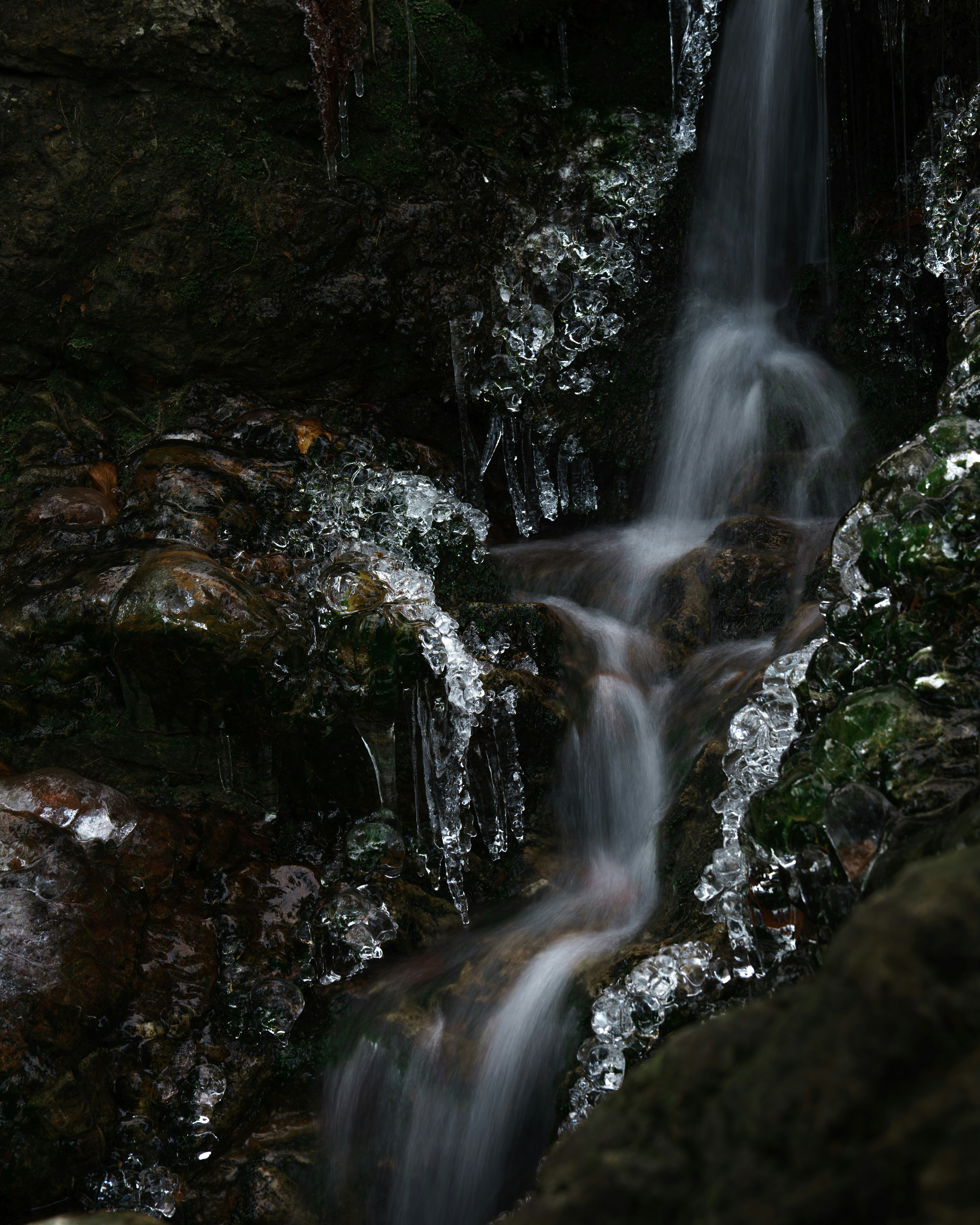 Whispering Cascade in a Dim Rock Nook