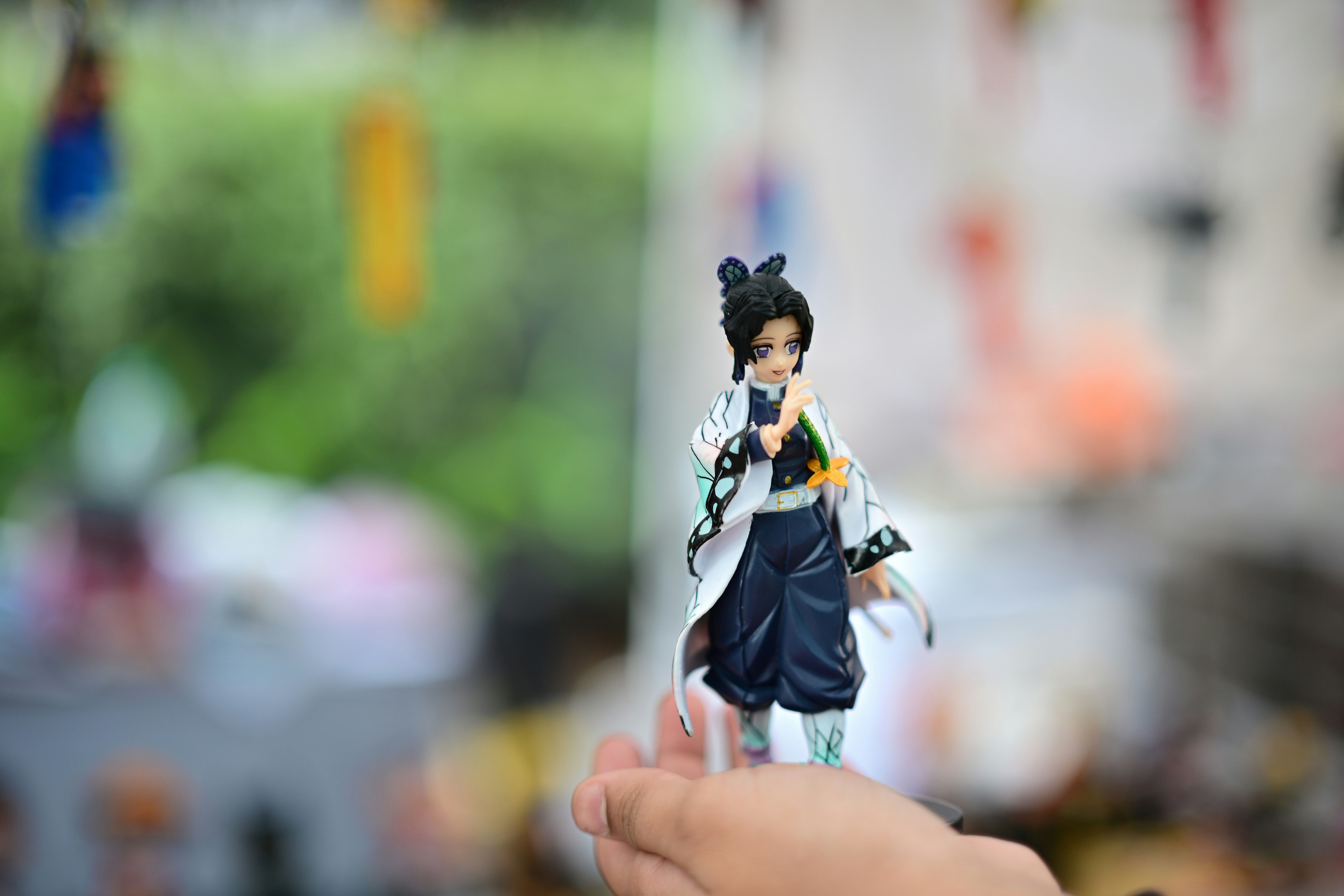Tiny Figurine, Big Focus: A Handheld Hero against a Soft City Blur
