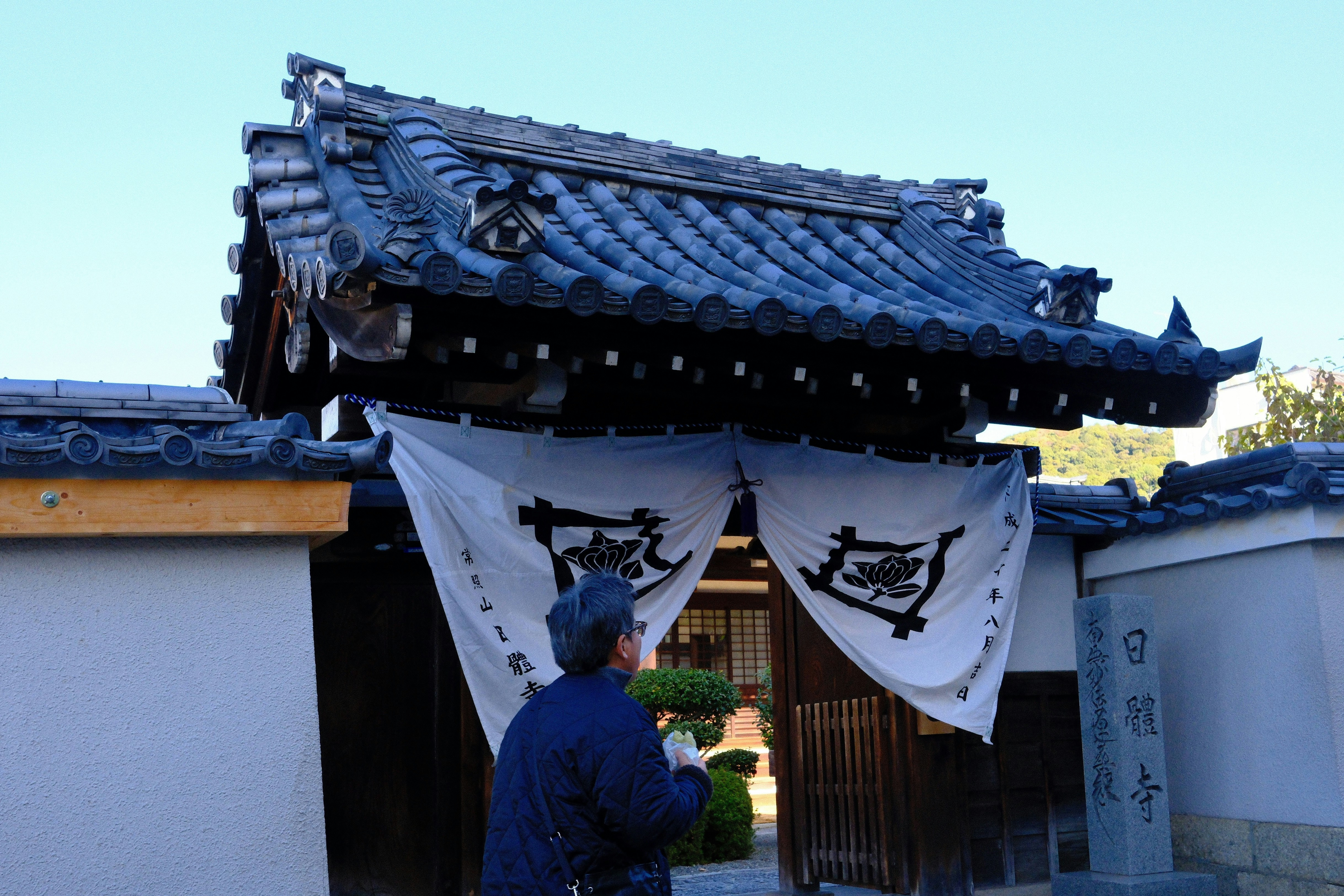 Entrance to a Serene Japanese Gate framed by a Traveler
