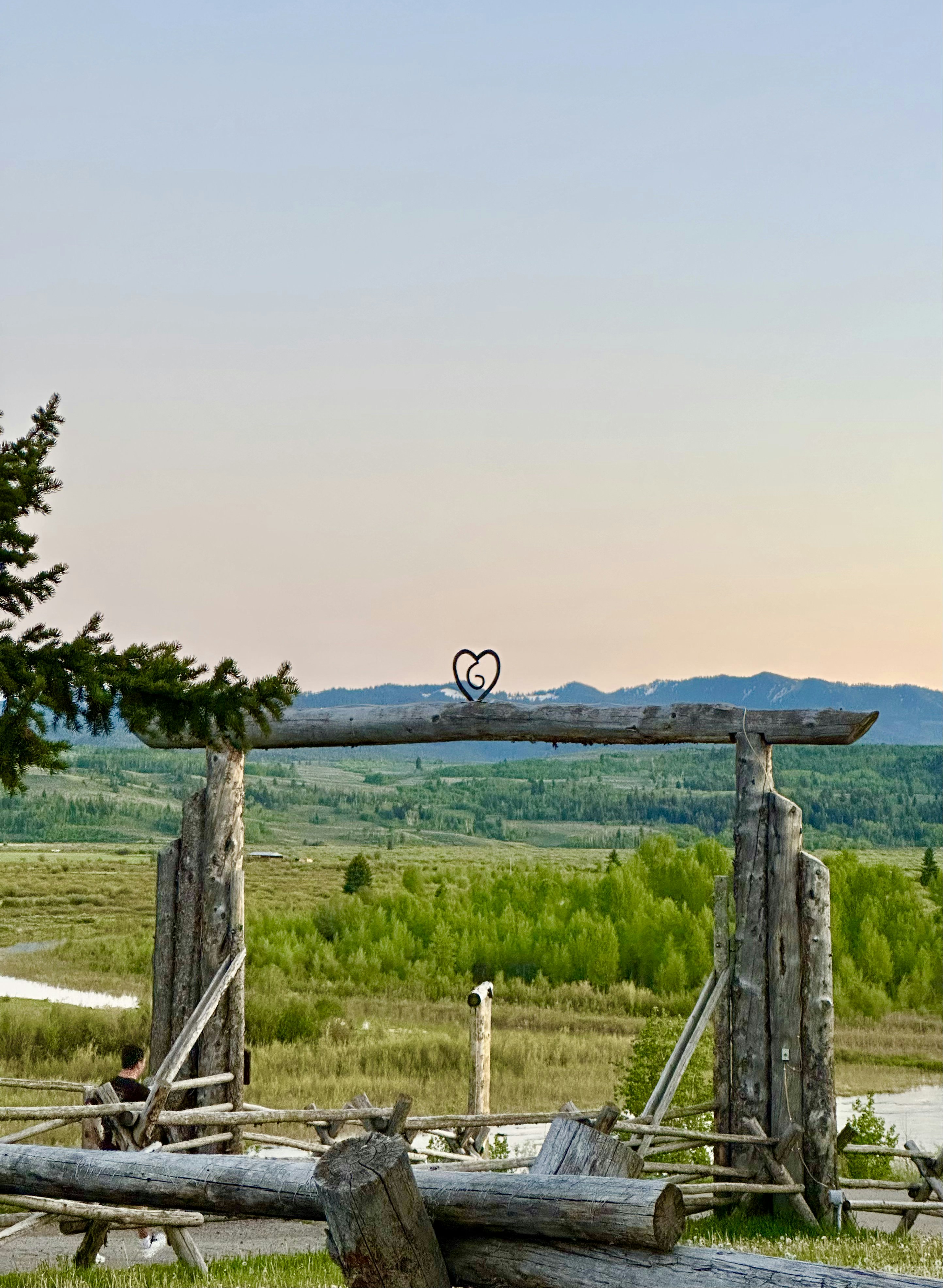 Heart on the Gate: Rustic Arch Framed by Valley Light
