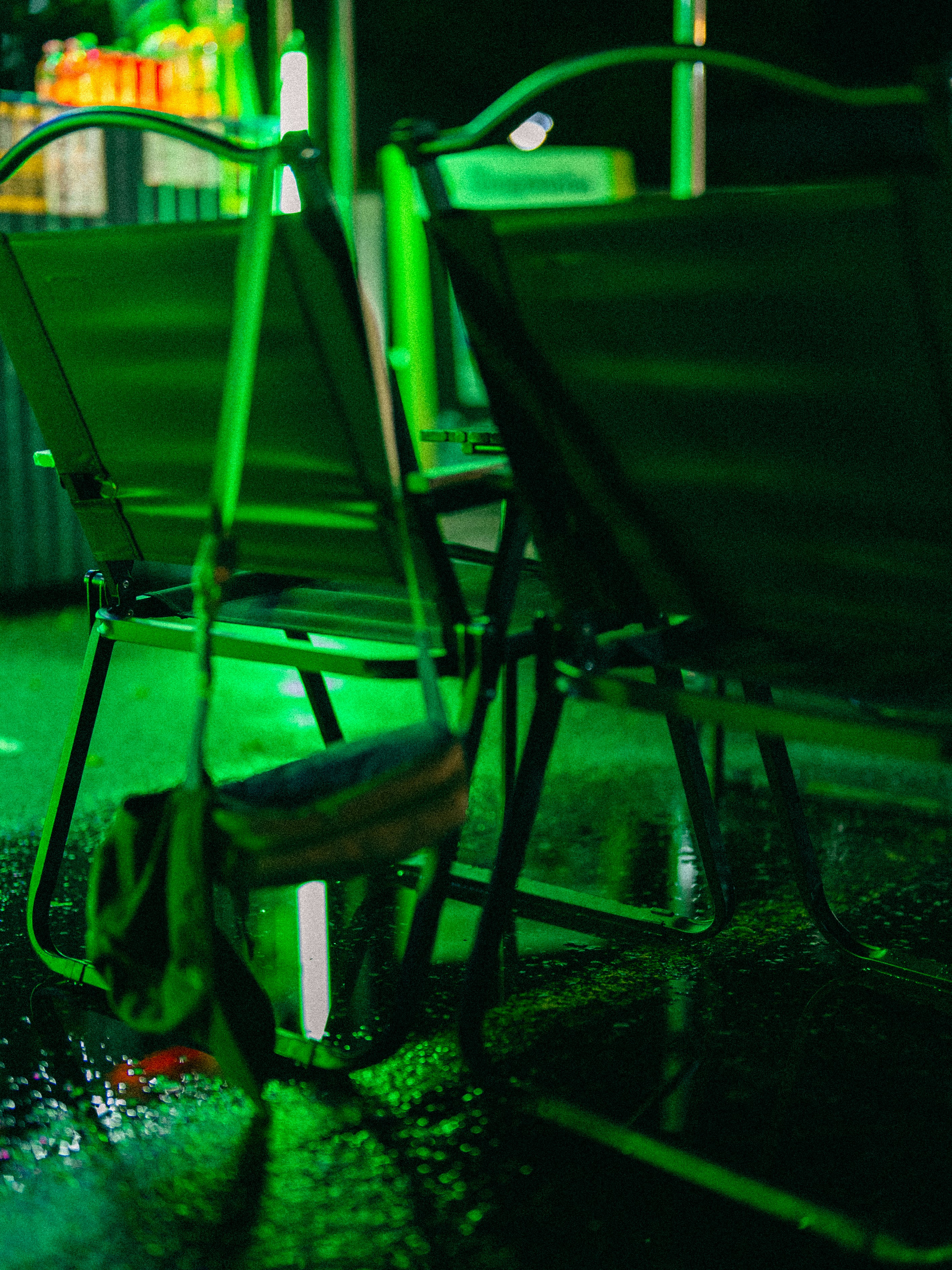 Green Neon Chairs in Rainy Nightlight