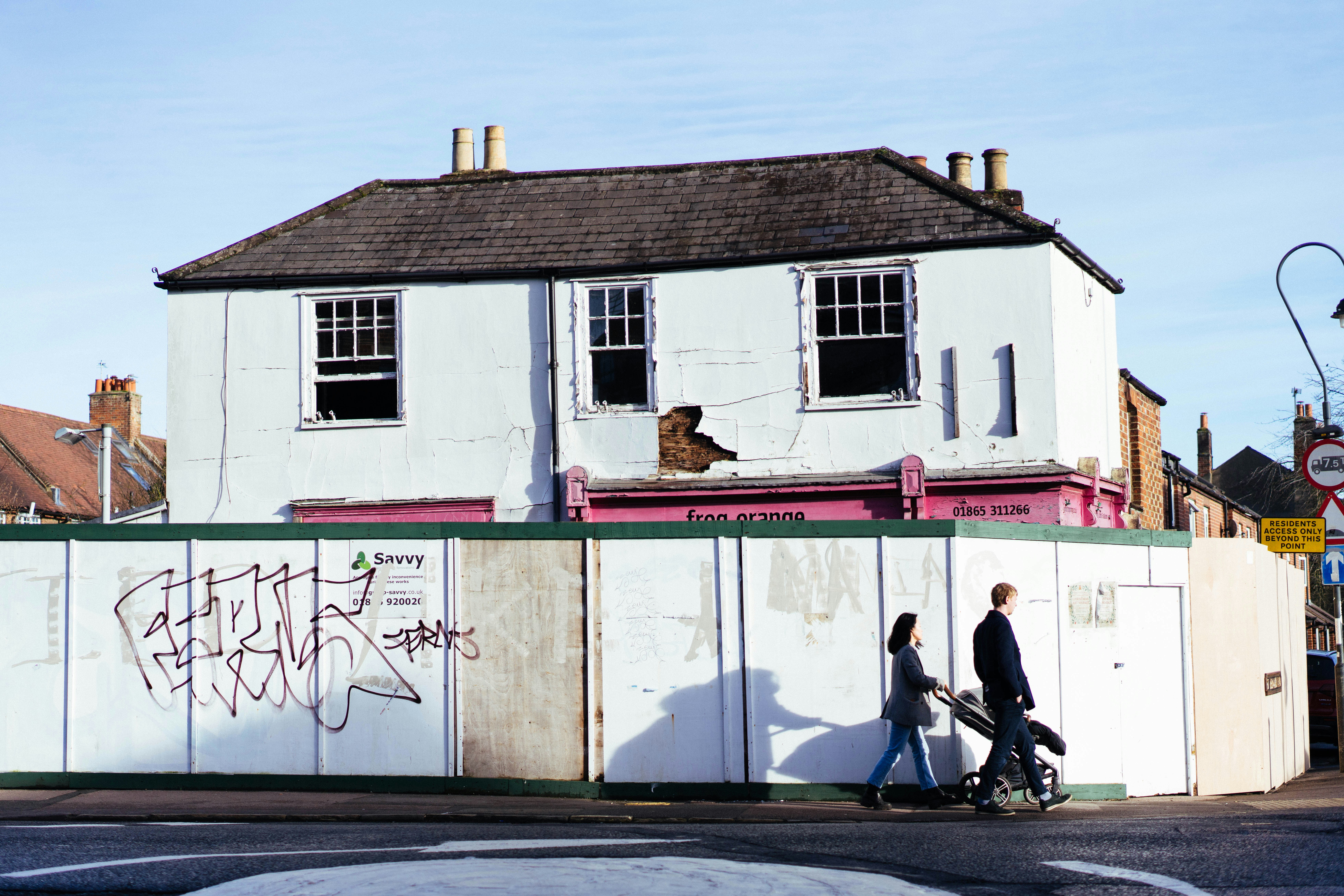 Construction Fence Portrait: A Quiet Street Breathes Through a Run-Down Terrace