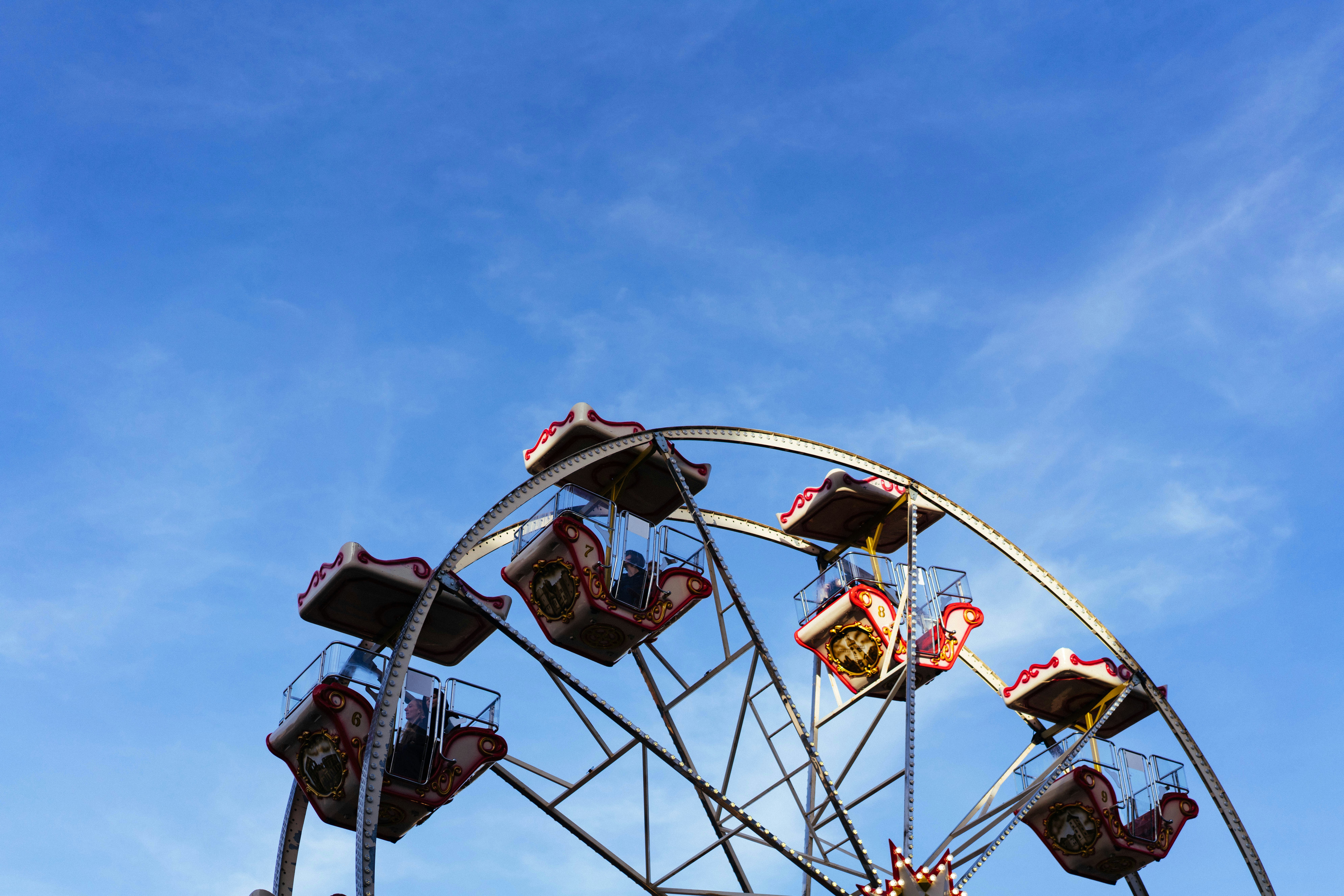 Carousel Circles: A Ferris Wheel Silhouette Against a Vast Blue Sky