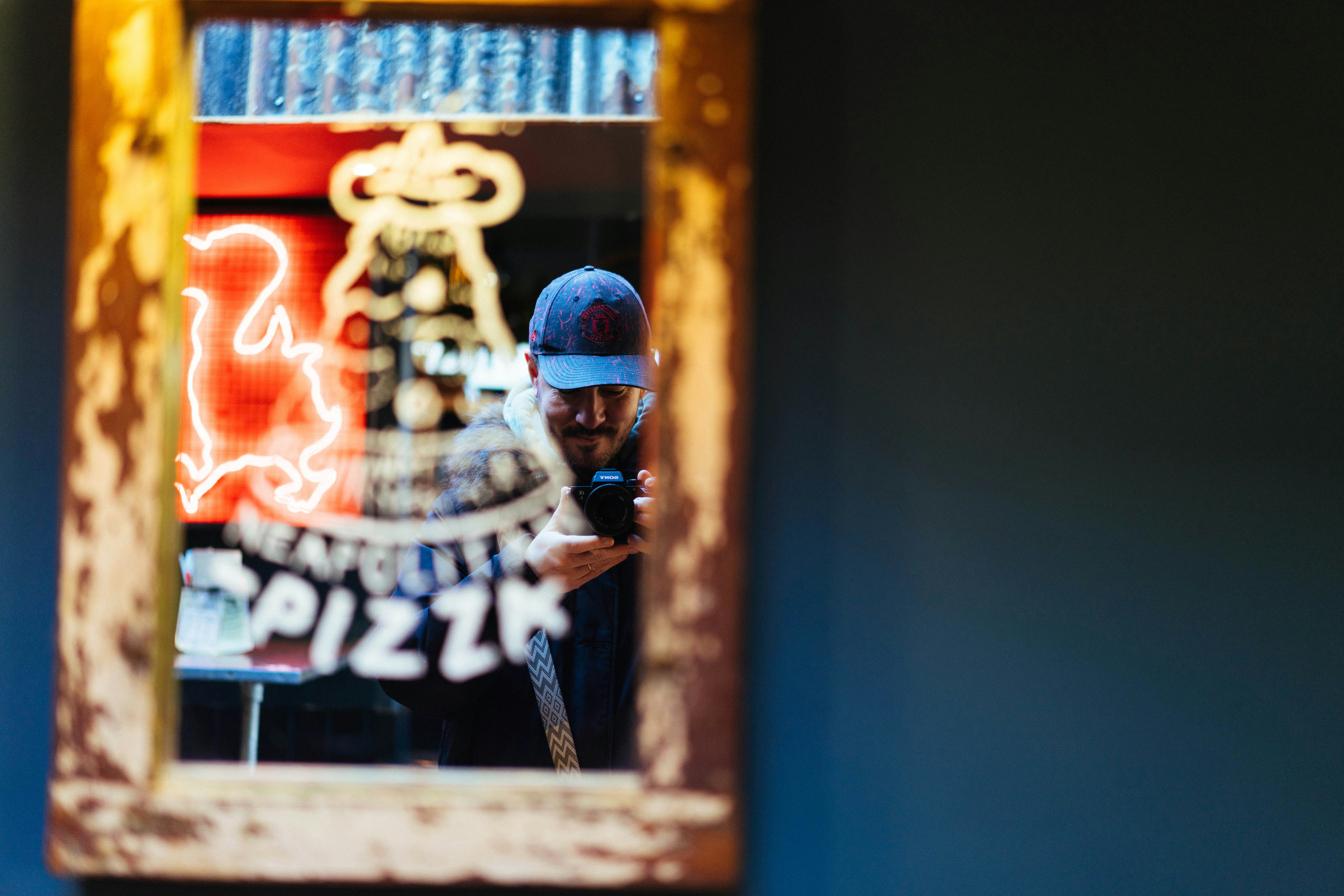 Reflected Focus: Neon Signage Framing a Quiet Moment