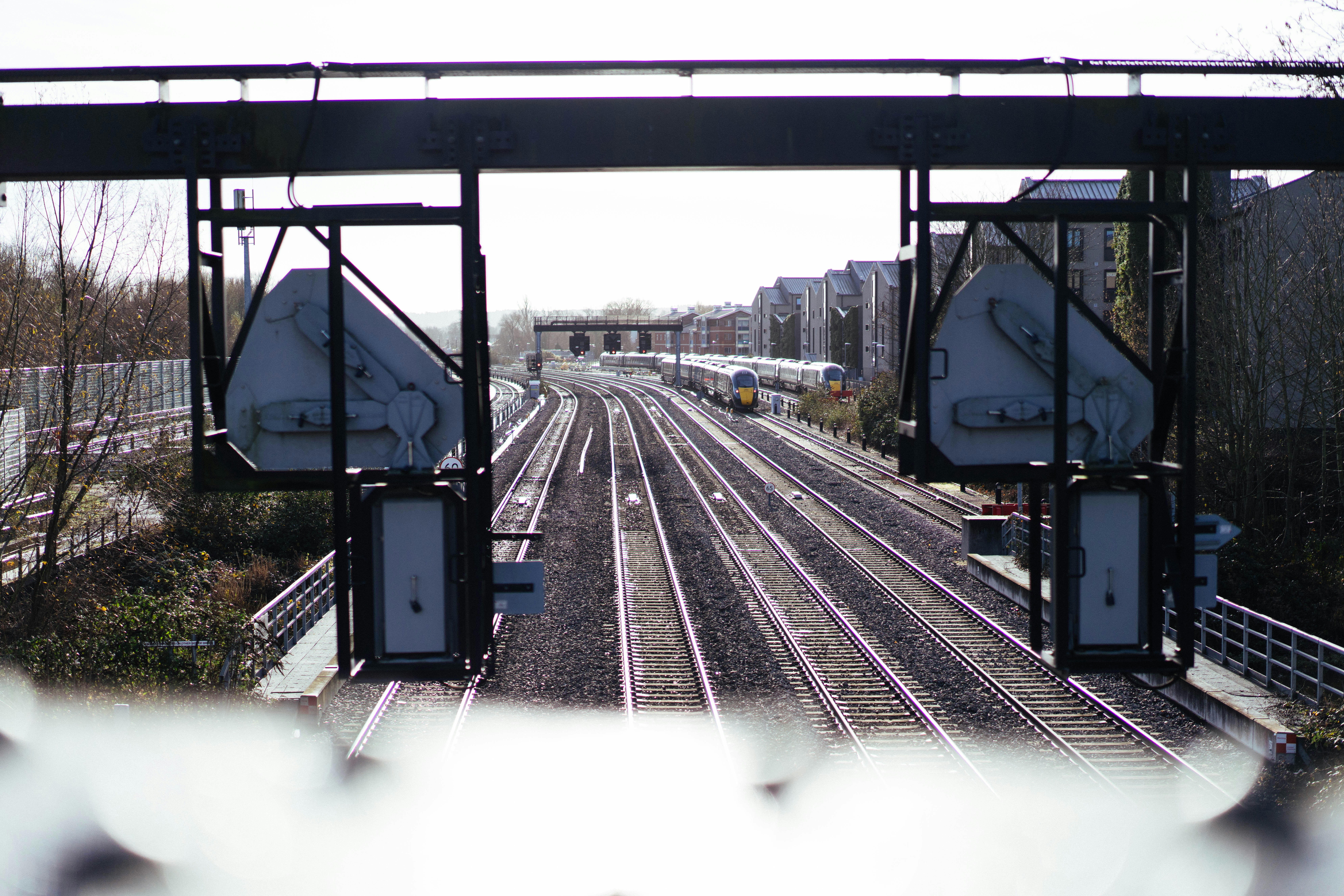 Converging Rails Under a Silent Bridge