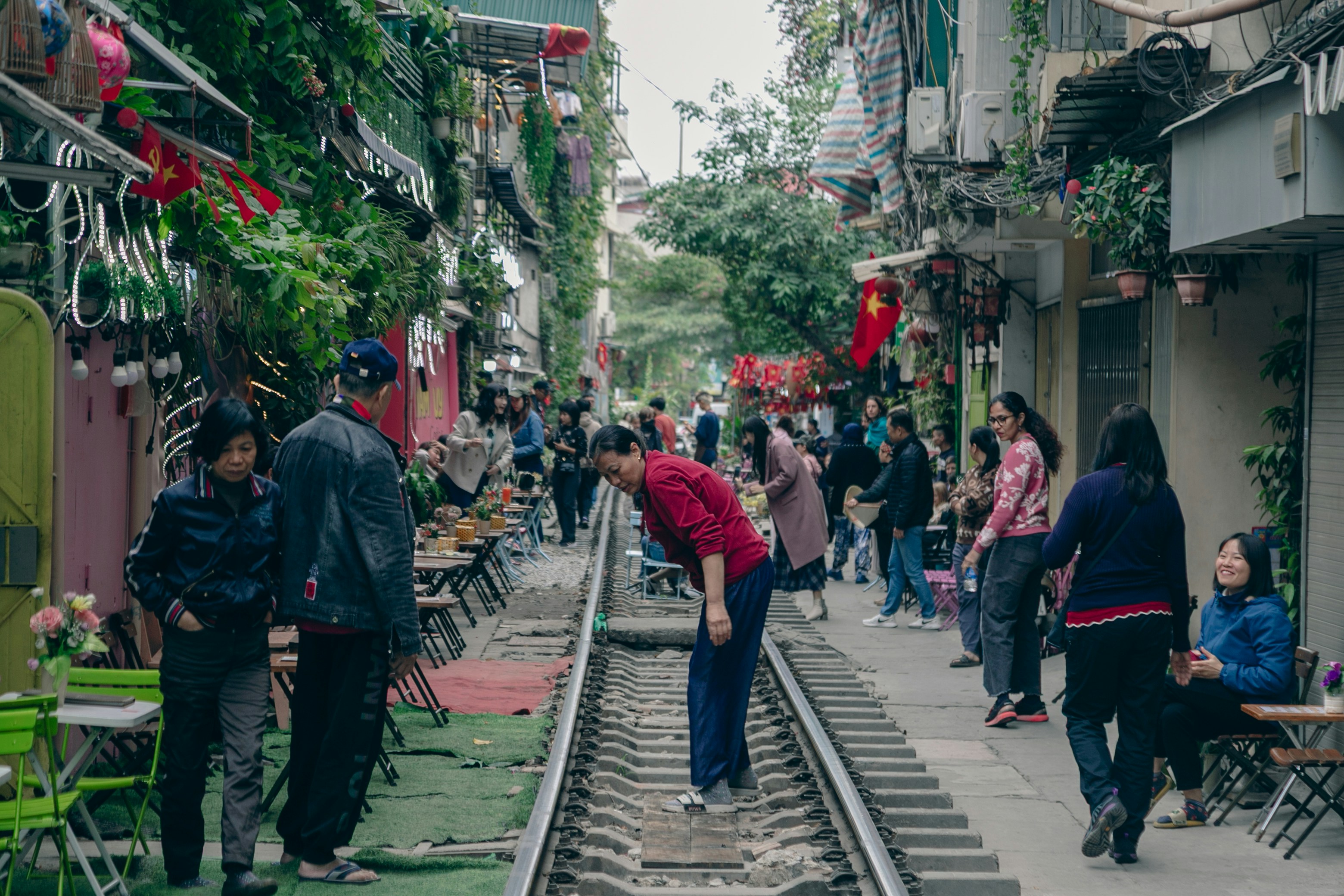Tracks of a lively alley: people, rails, and urban color