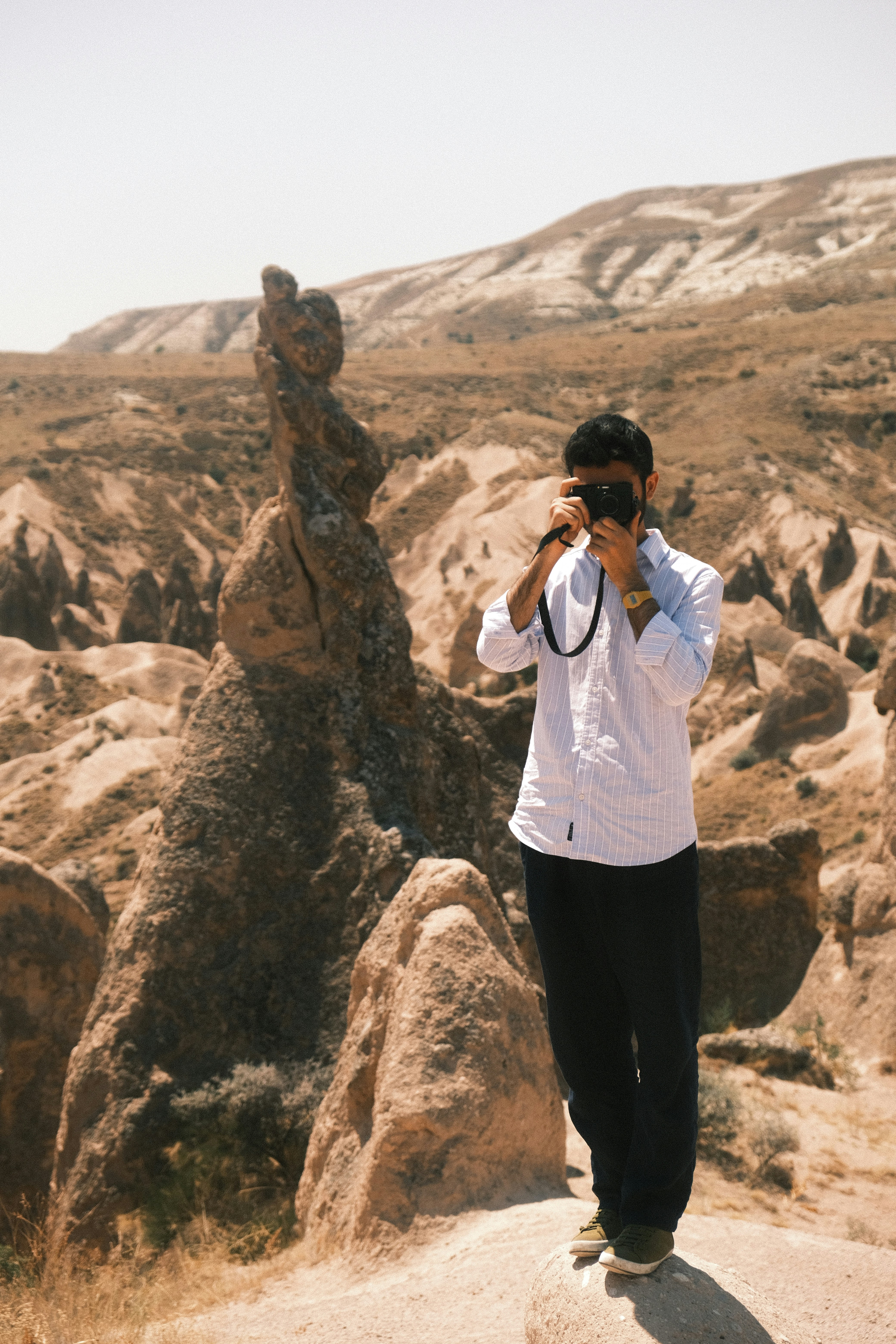 Portrait on a Desert Spire: A Photographer in Echoing Valleys