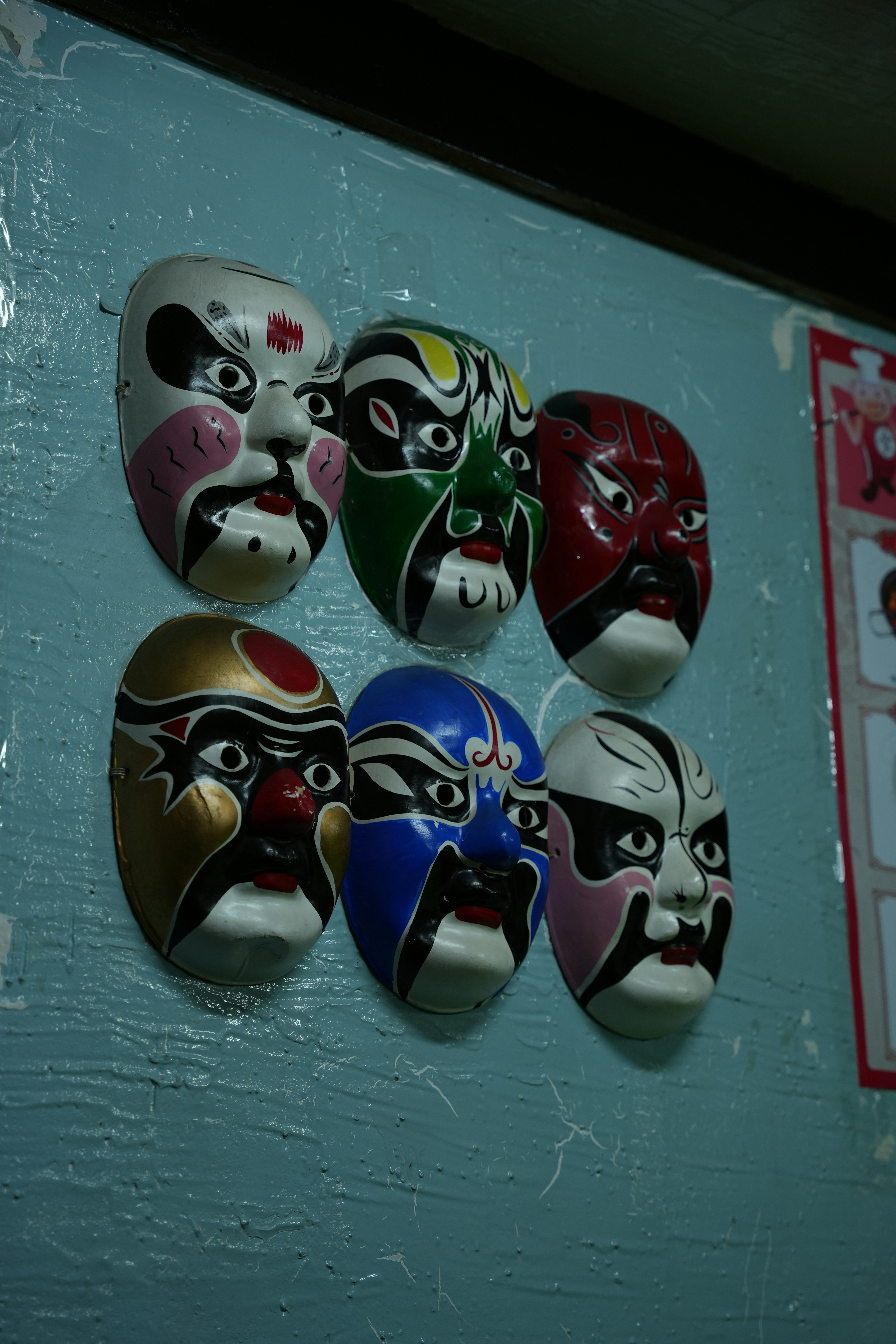 Masked Faces on a Bluesy Wall