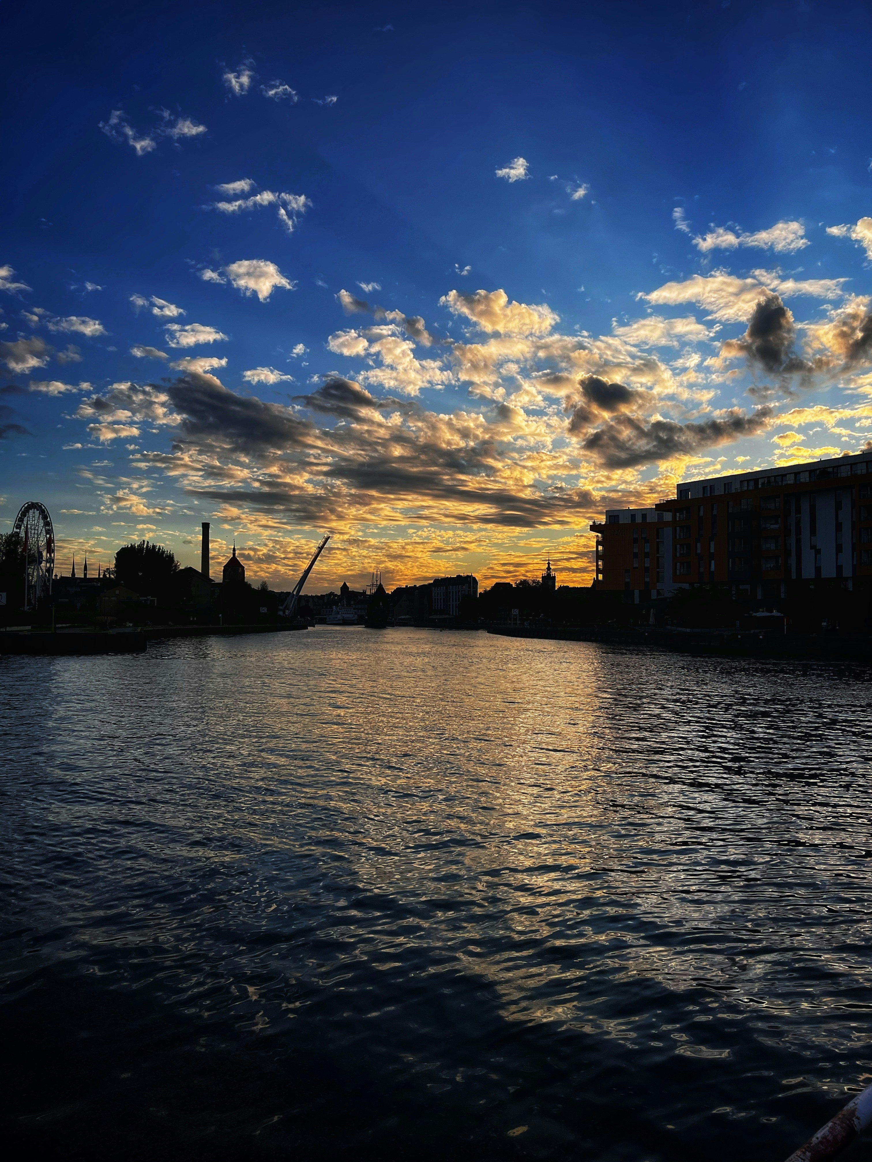 Sunset Silhouette Over a Calm Waterfront