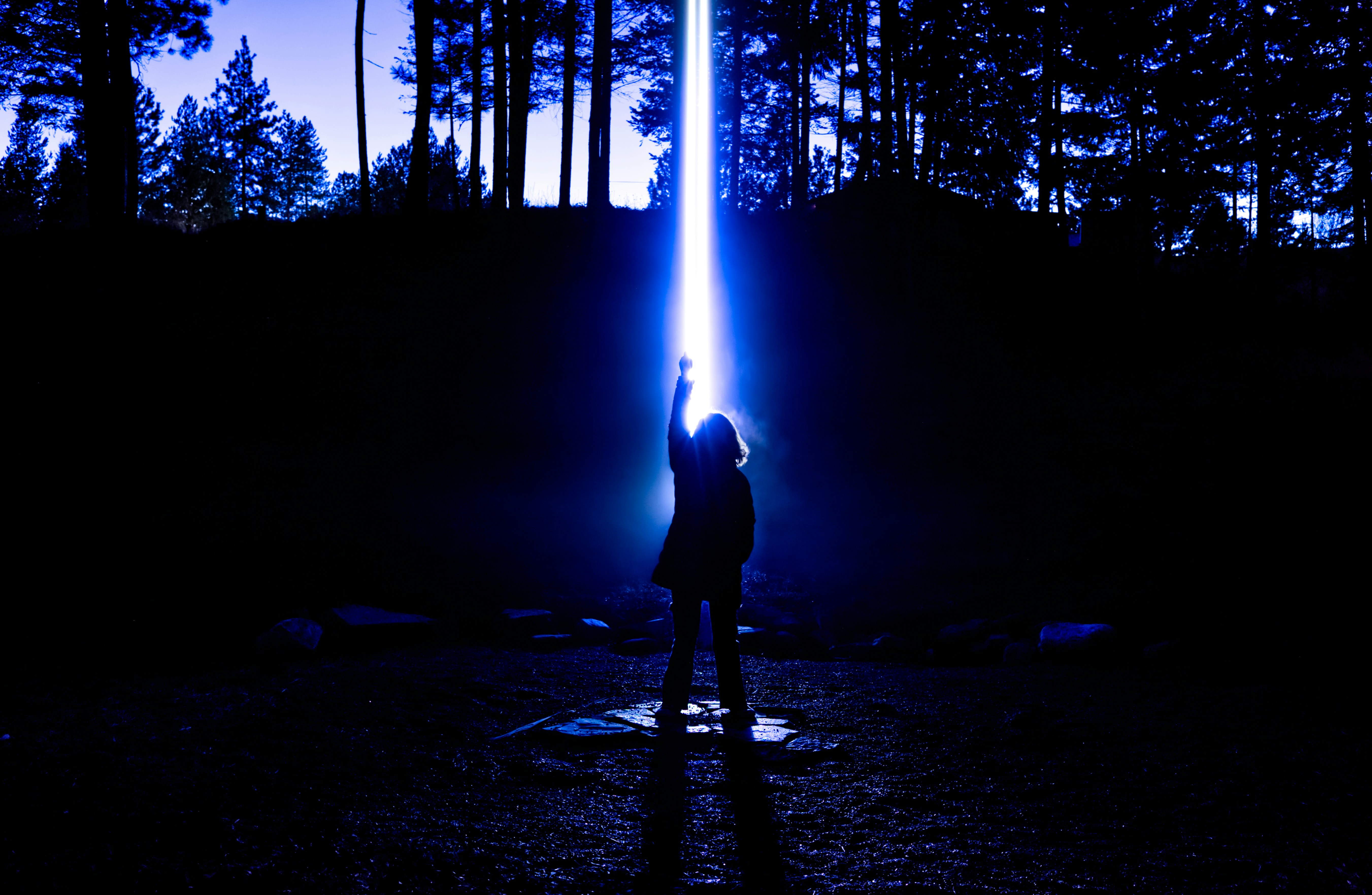 Person reaching for a bright blue light beam. photo – Free Forest Image ...