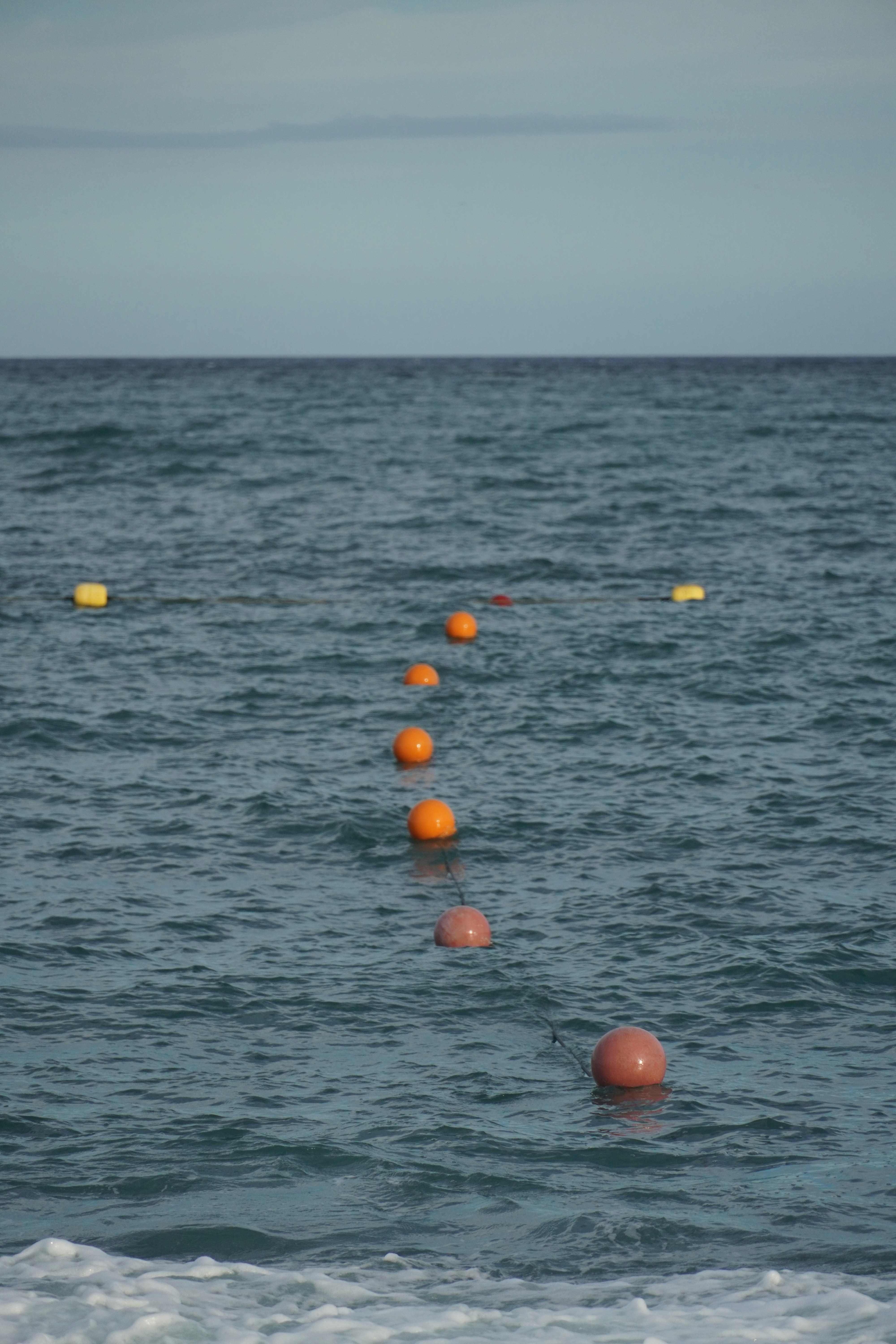 Floating Buoys Line the Horizon