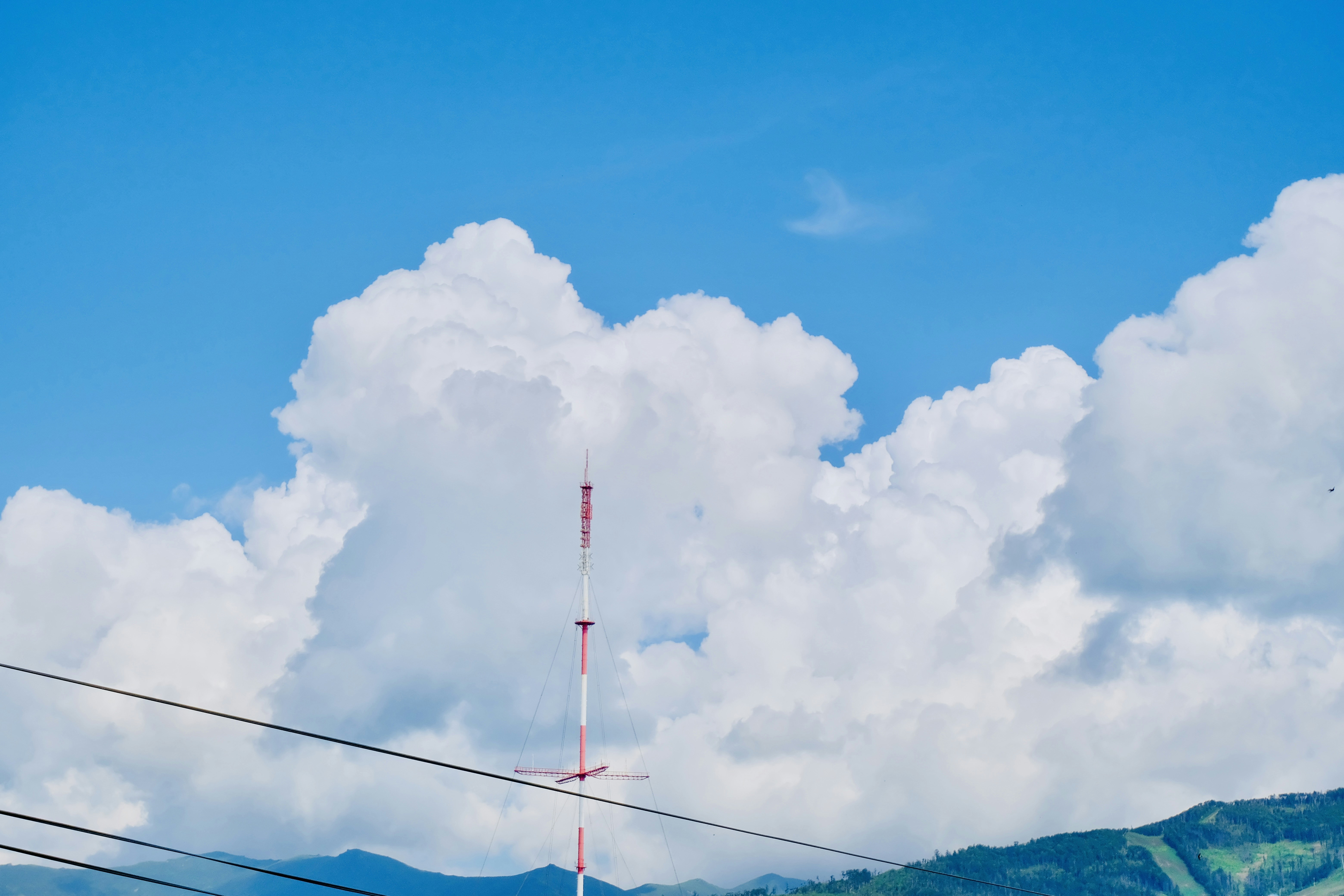 Tower Against a Sky of Fluffy Peaks