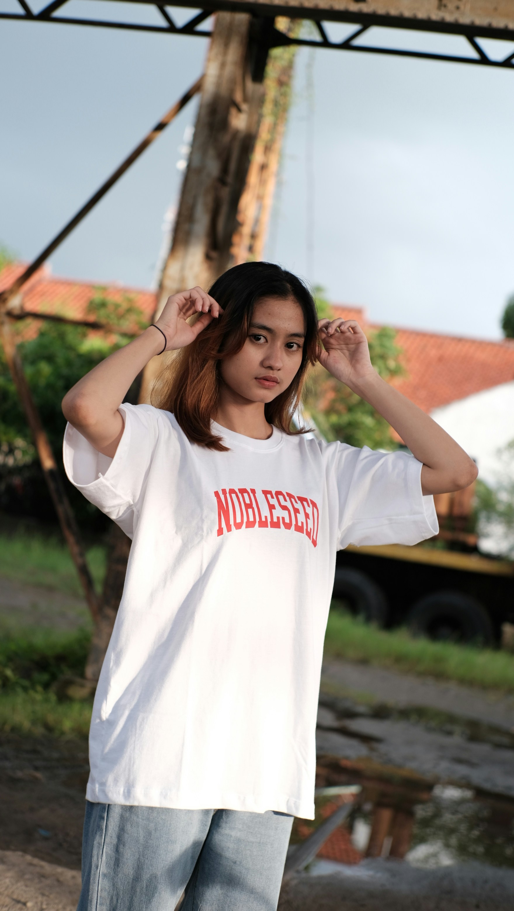 Portrait Under Industrial Arch: A Quiet Moment with a White Tee