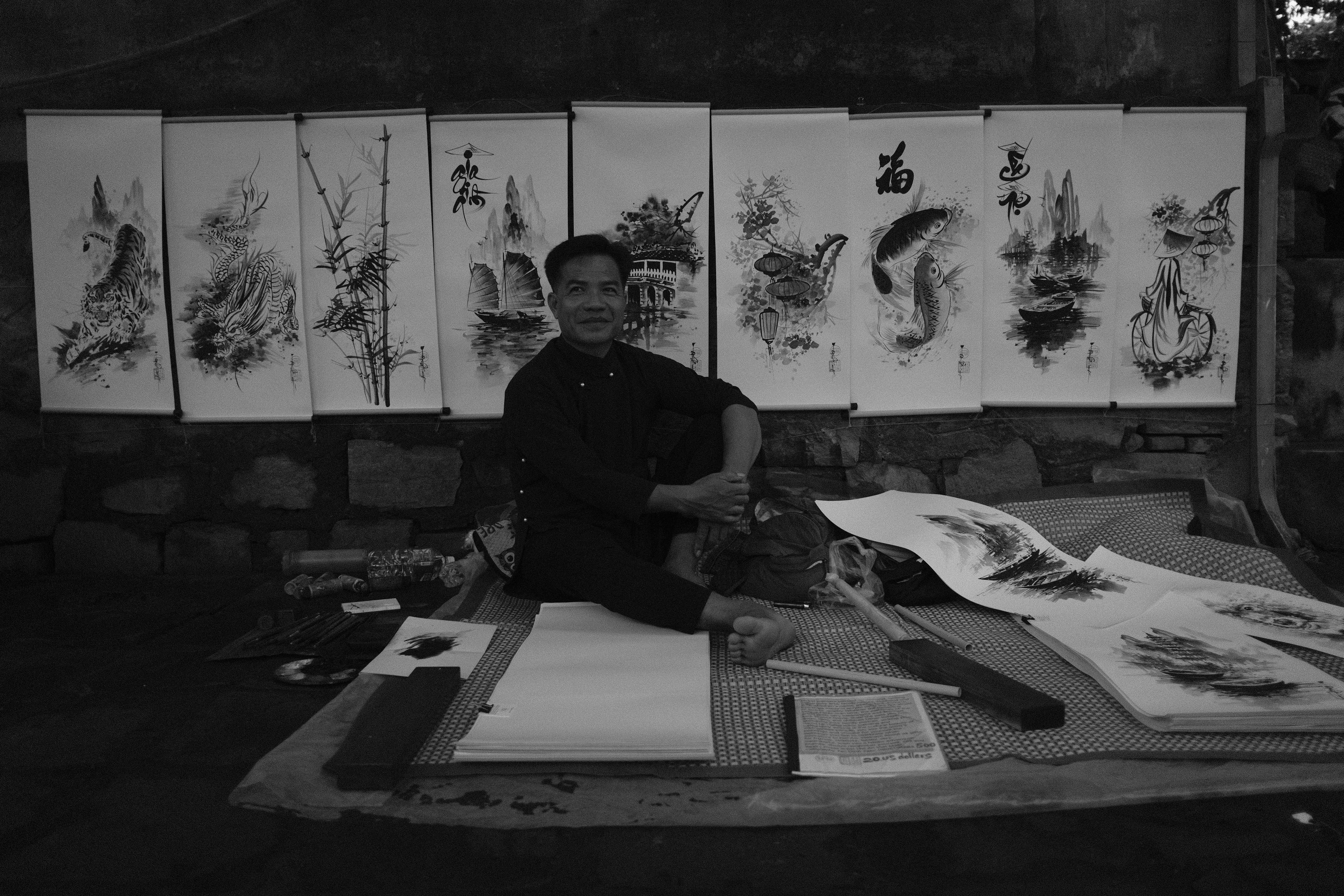 Silk-ink Studio: A Portrait of Focus Amid Hanging Scrolls