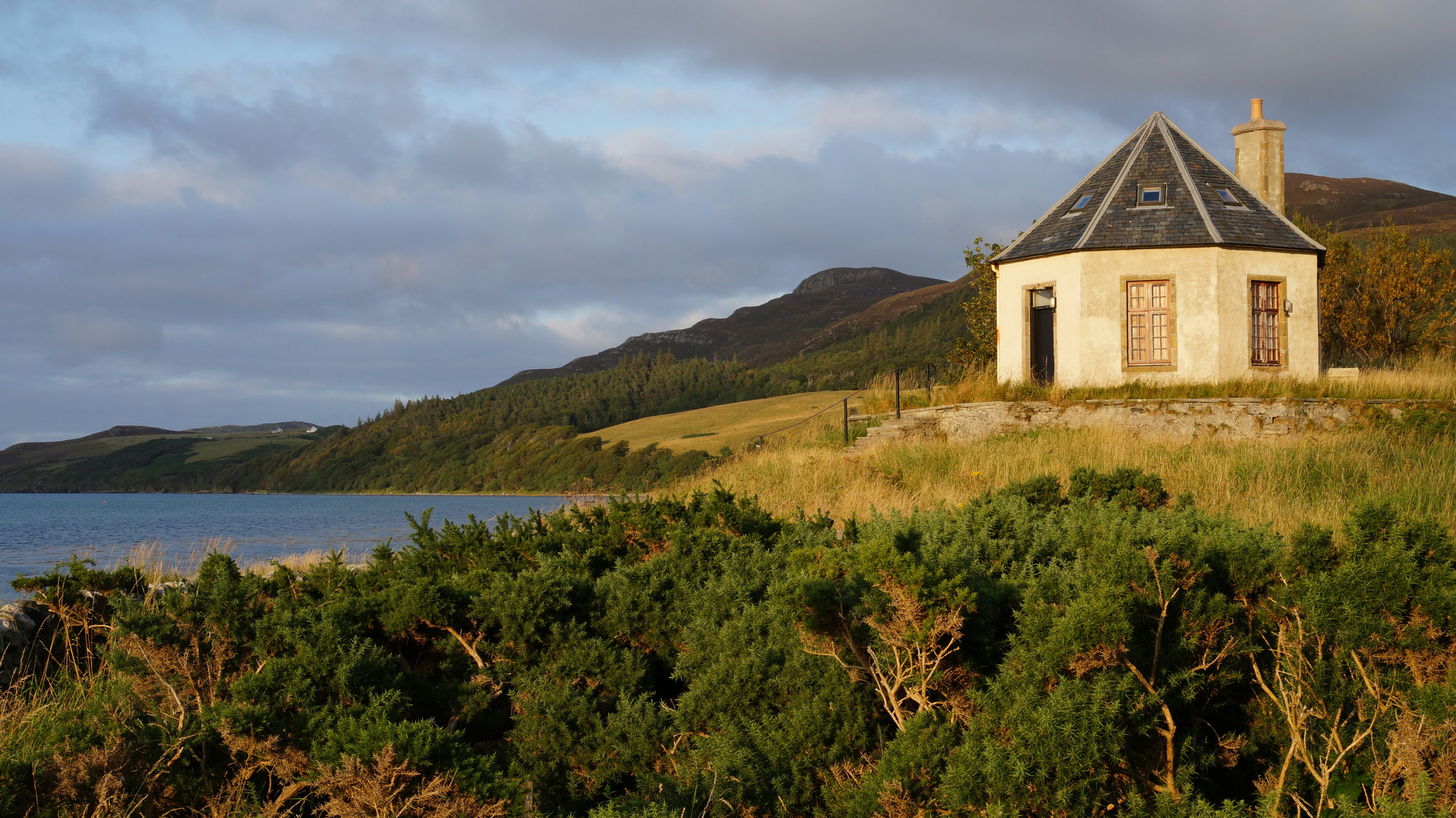 Small stone house on a hill overlooking water